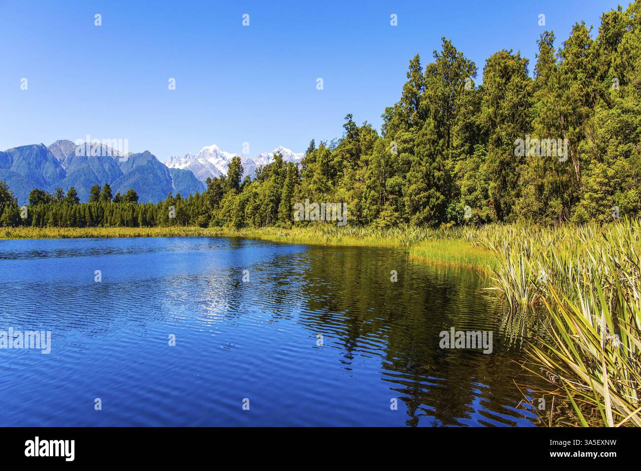 The famous lake Matheson reflects Mount Cook and Mount Tasman. Lake ...
