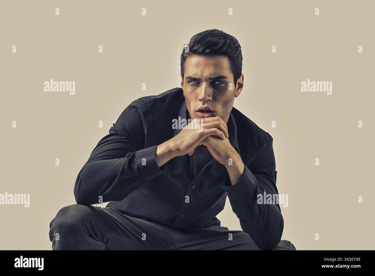 Portrait of a Young Vampire Man with Black Leather Jacket Sitting on ...