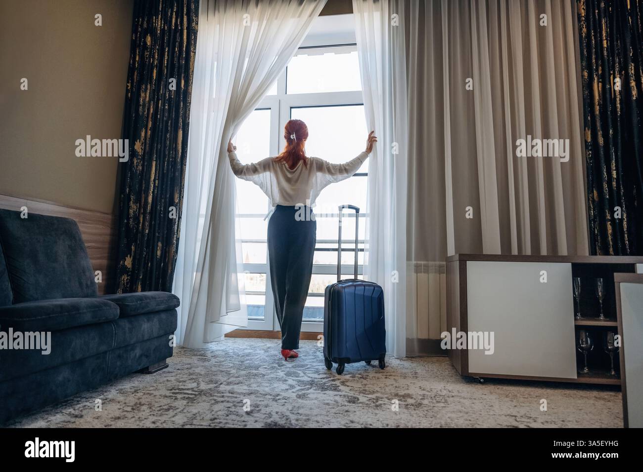 Opens the curtains. Woman is in the hotel room, modern interior Stock ...