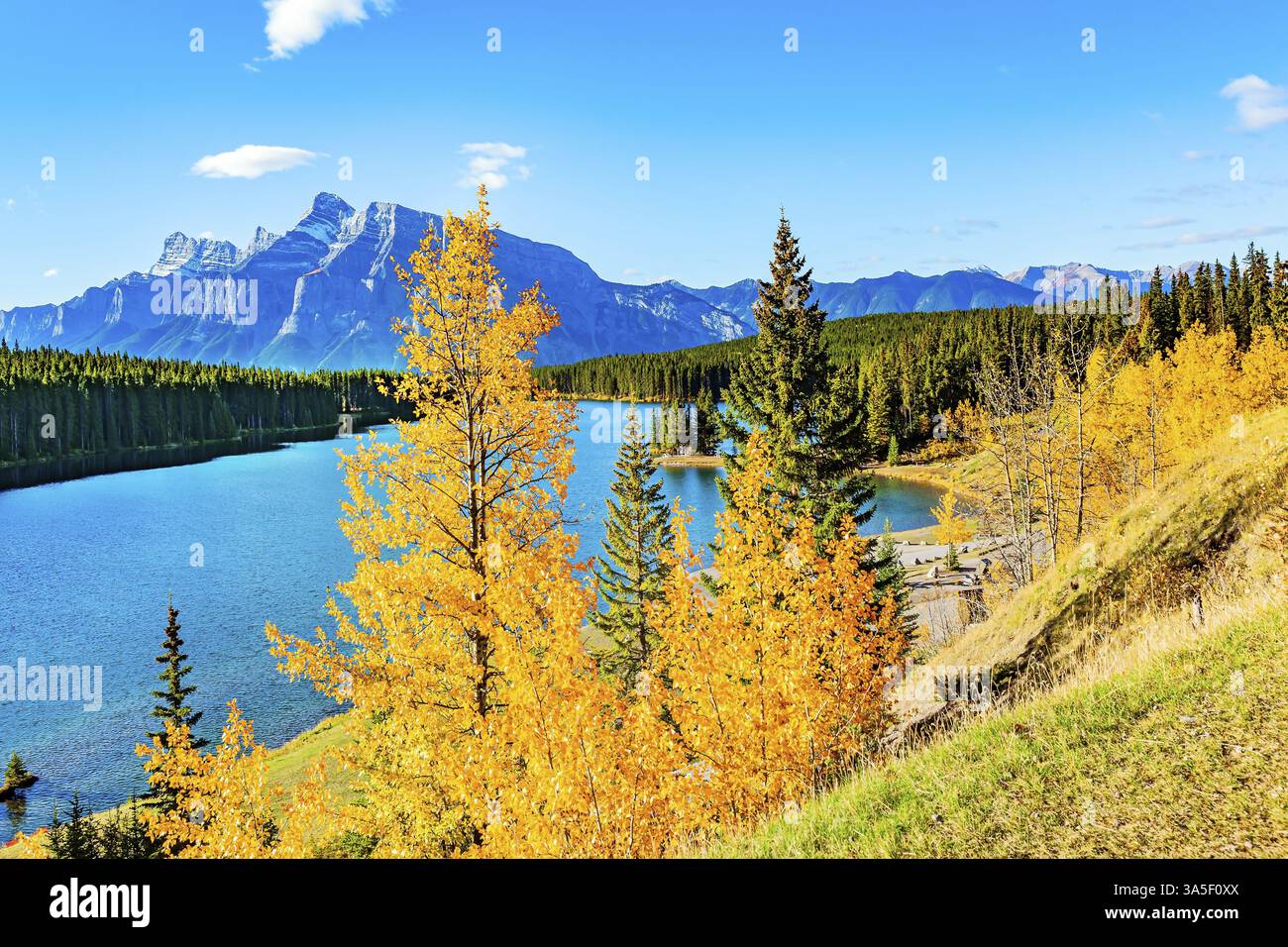 The cold emerald green waters of the lake reflect the surrounding ...