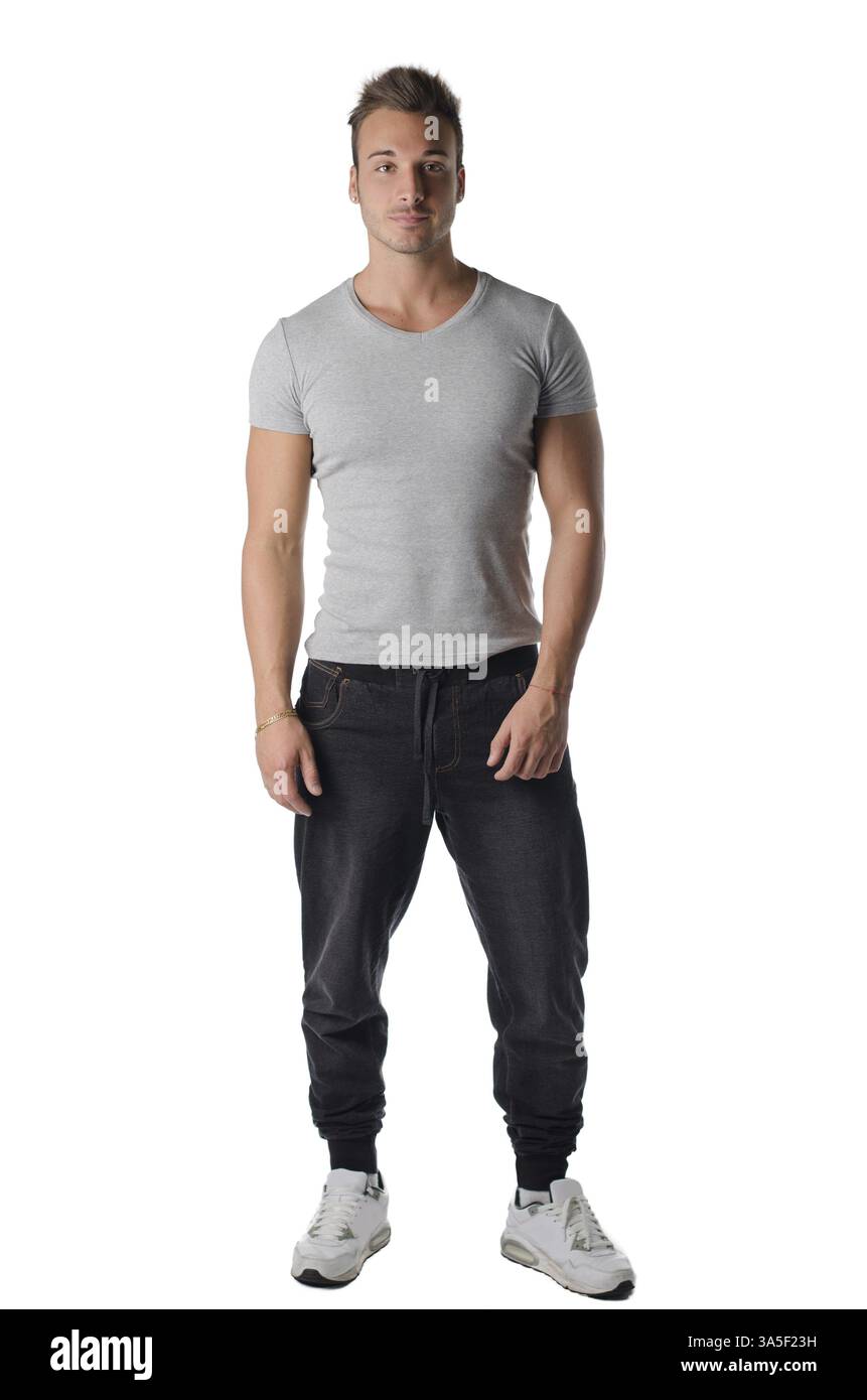 Attractive young muscle man in grey t-shirt and sporty pants, isolated ...