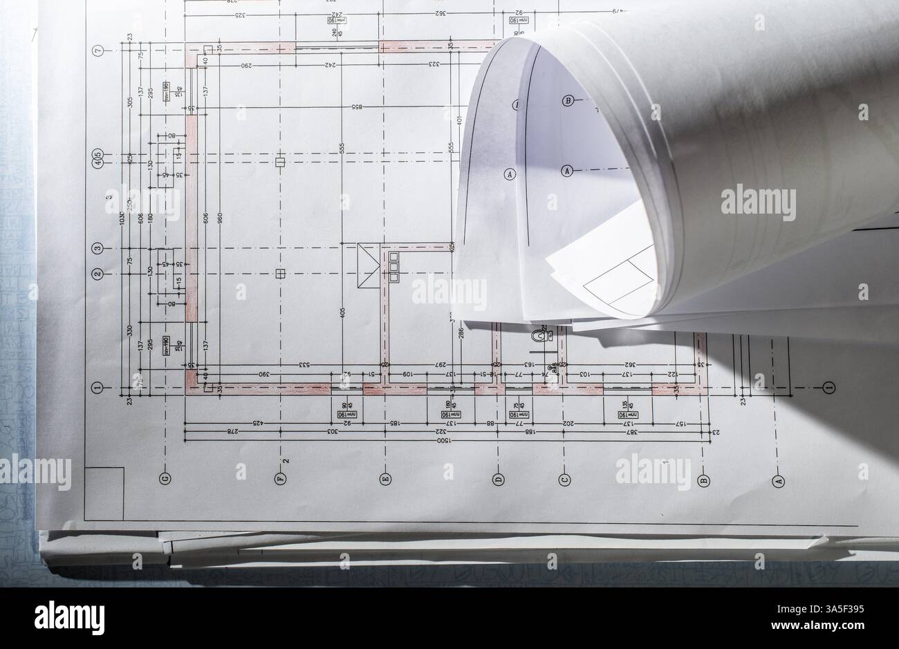 Blueprints on architect desk. Stacked and rolled up architectural ...