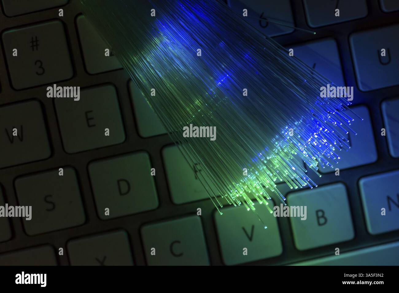 Colourful optic fibers illuminated on keyboard. High speed internet ...