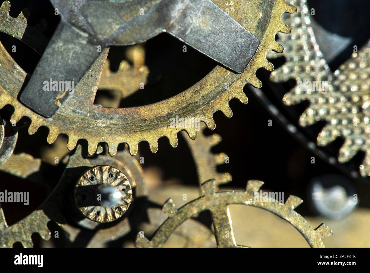 Close up metal gears mechanism. Golden colours. Hard light. Clock ...