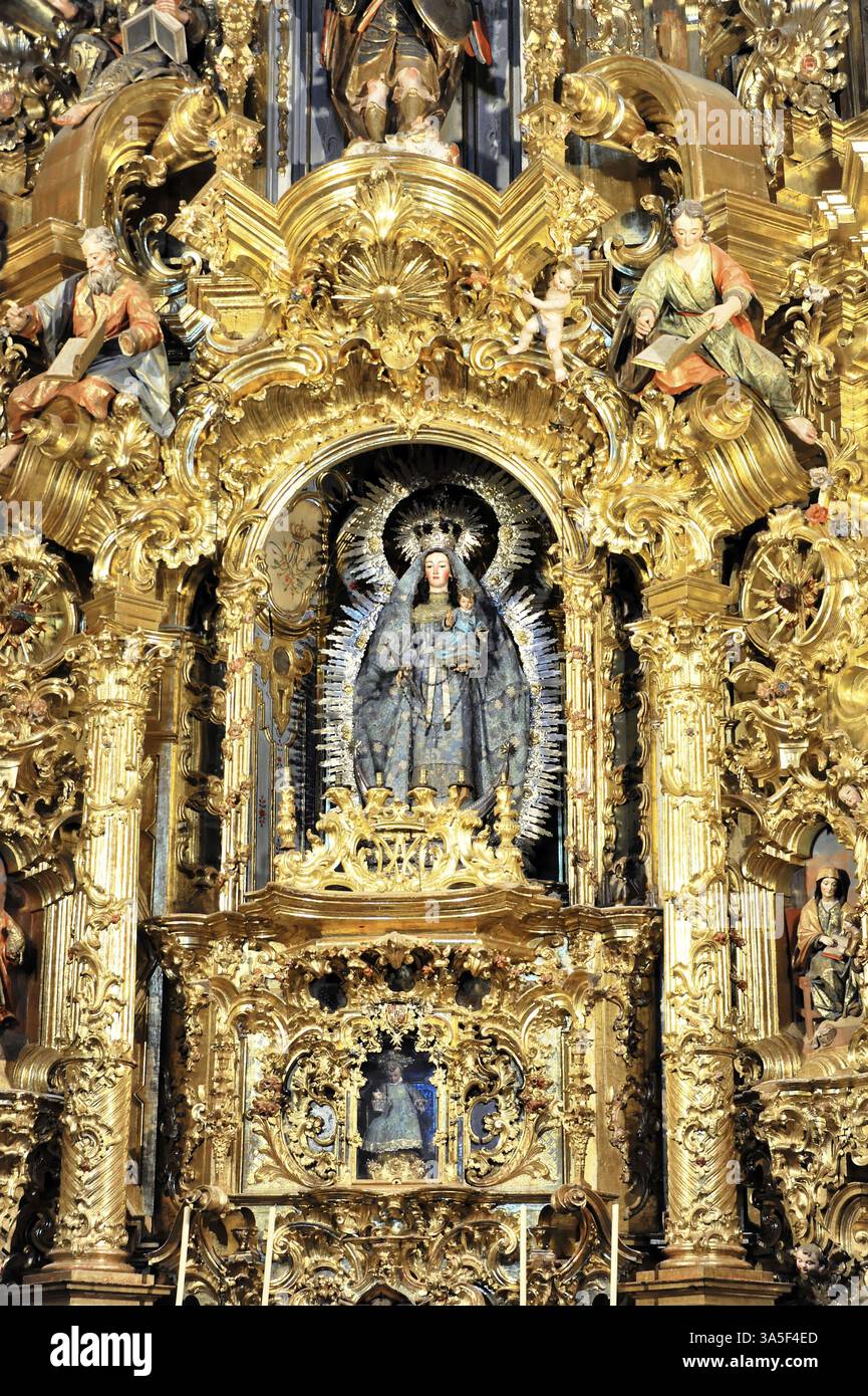 Magnificently decorated golden baroque altar with detailed sculptures ...