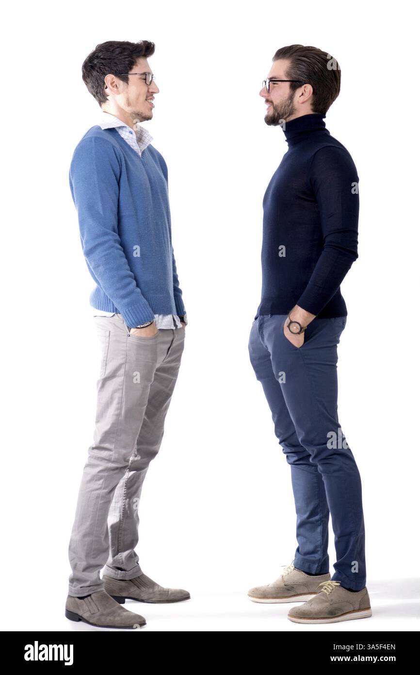 Two good-looking young men with eye-glasses in stylish clothes, looking ...