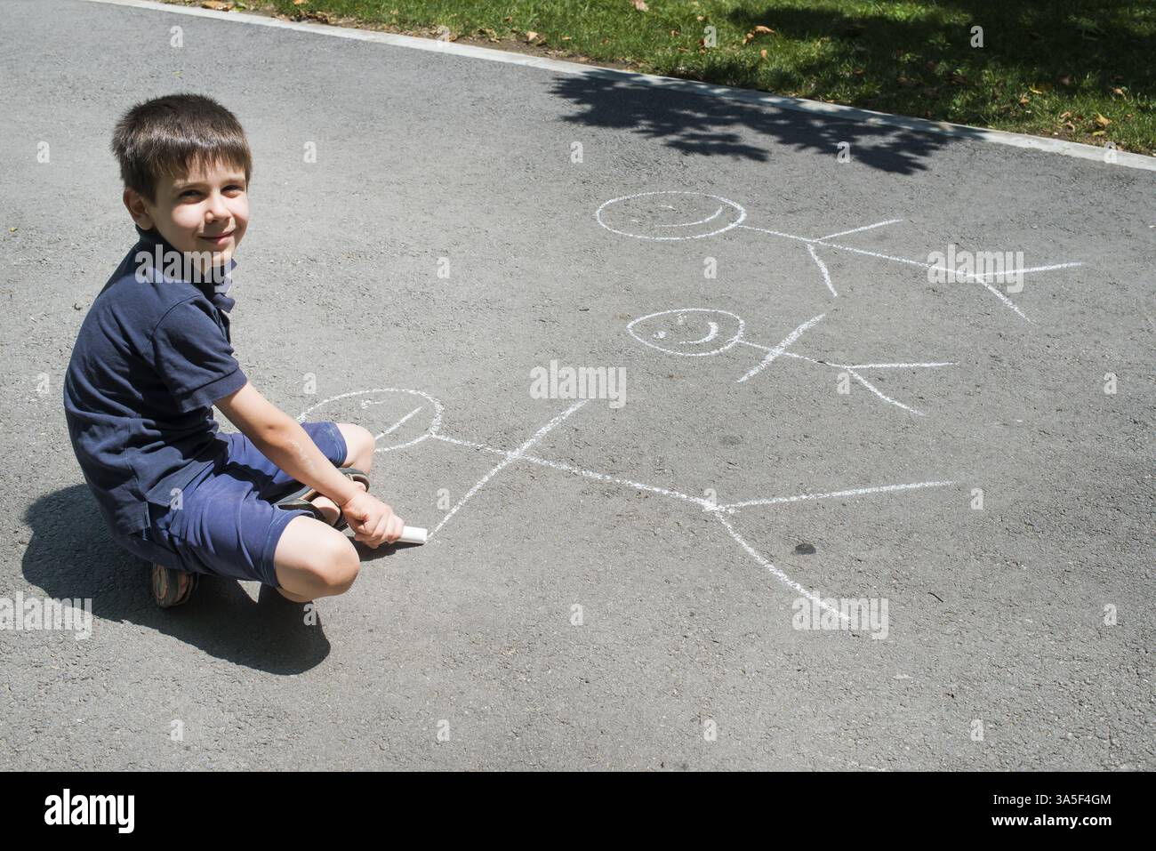 Child drawing family on asphalt in a park Stock Photo - Alamy