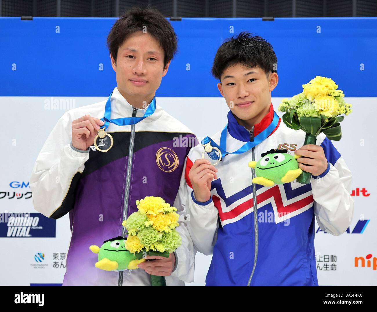 Rikuto Tamai (R) and Shu Okubo smile with their medals after winning ...