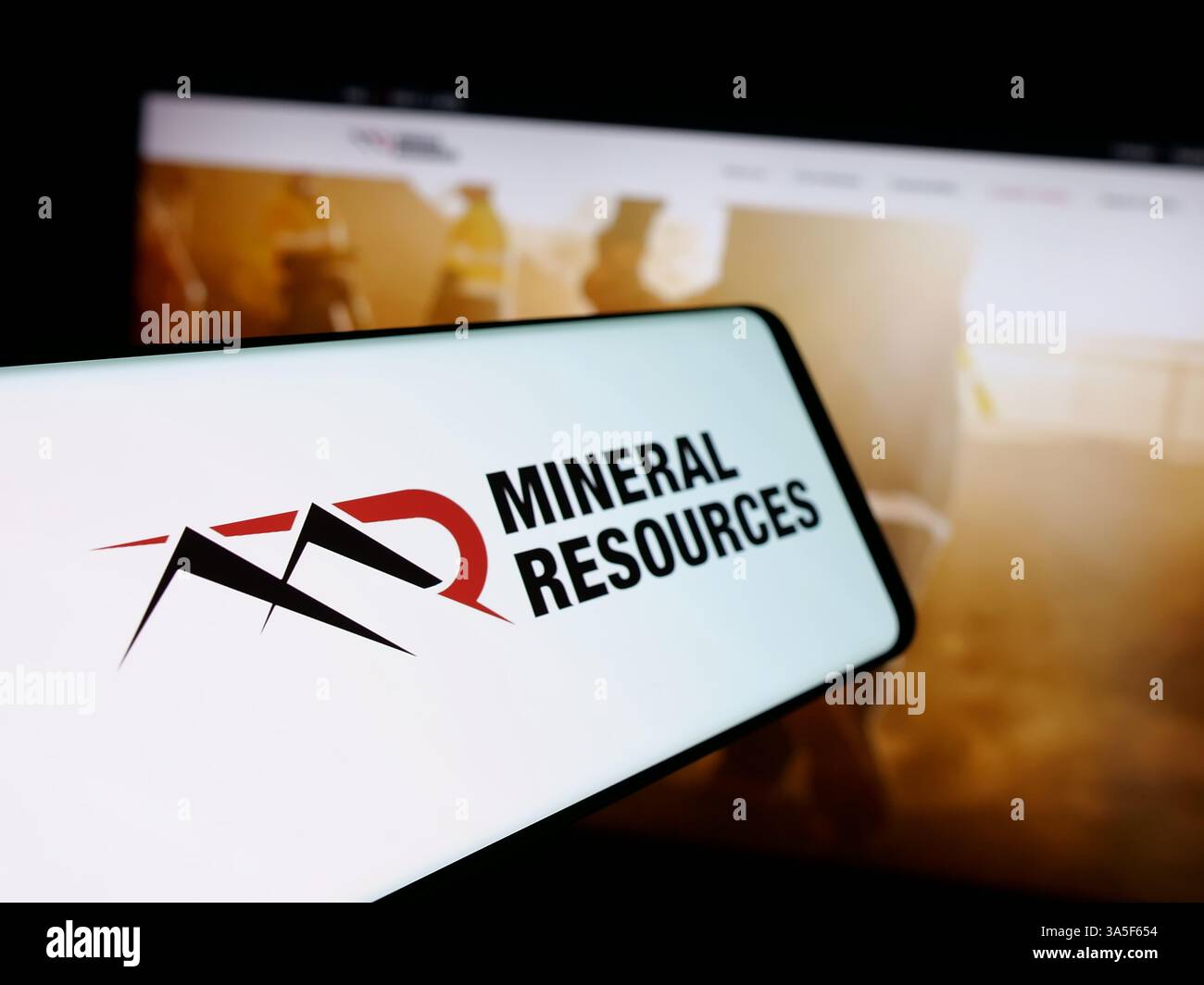 In this photo illustration, a mobile phone with the logo of mining ...