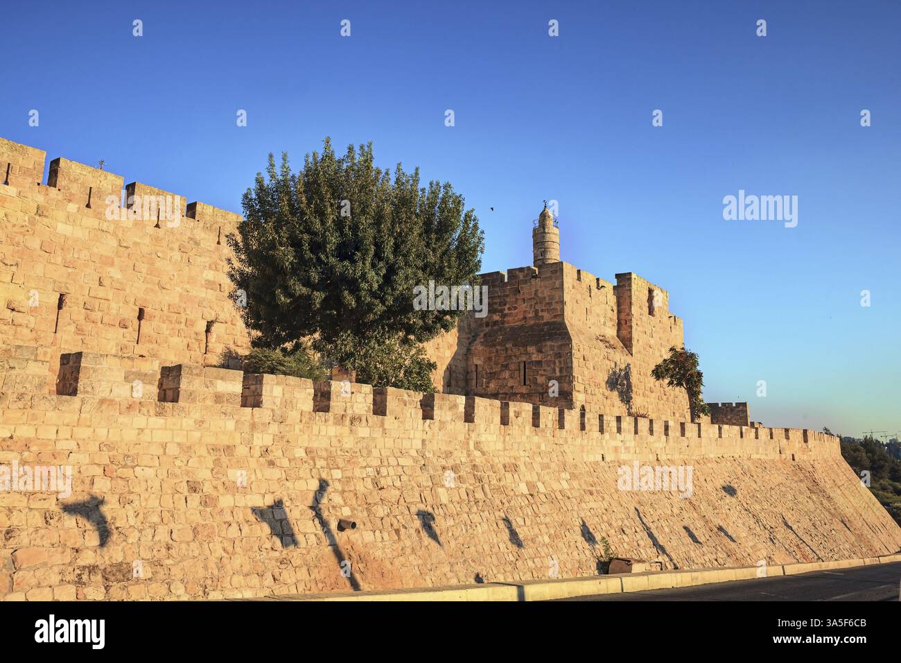Protective powerful walls of the Old City of Jerusalem at sunset ...