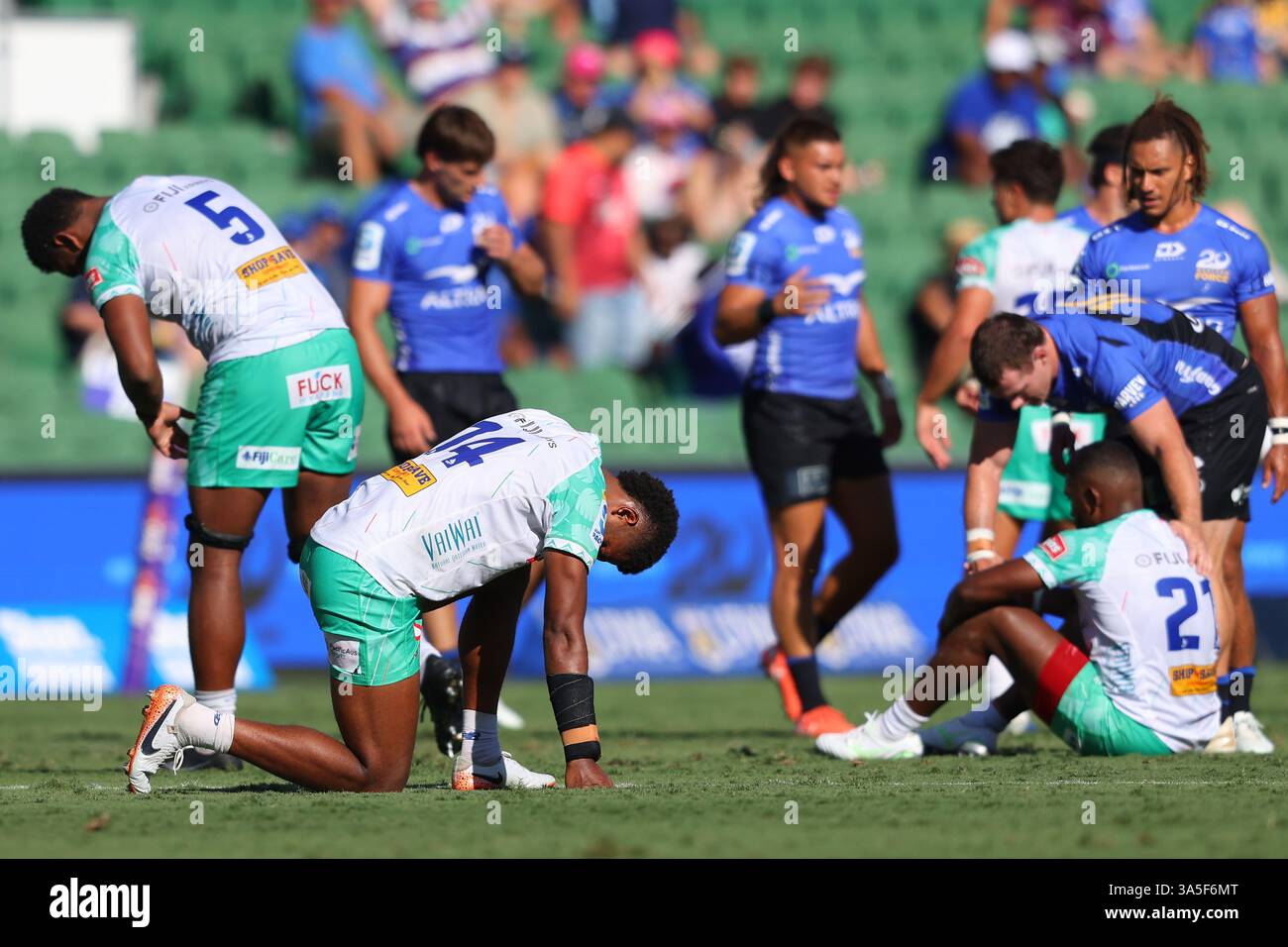 Disappointed Drua players sit on the field after losing Super Rugby ...