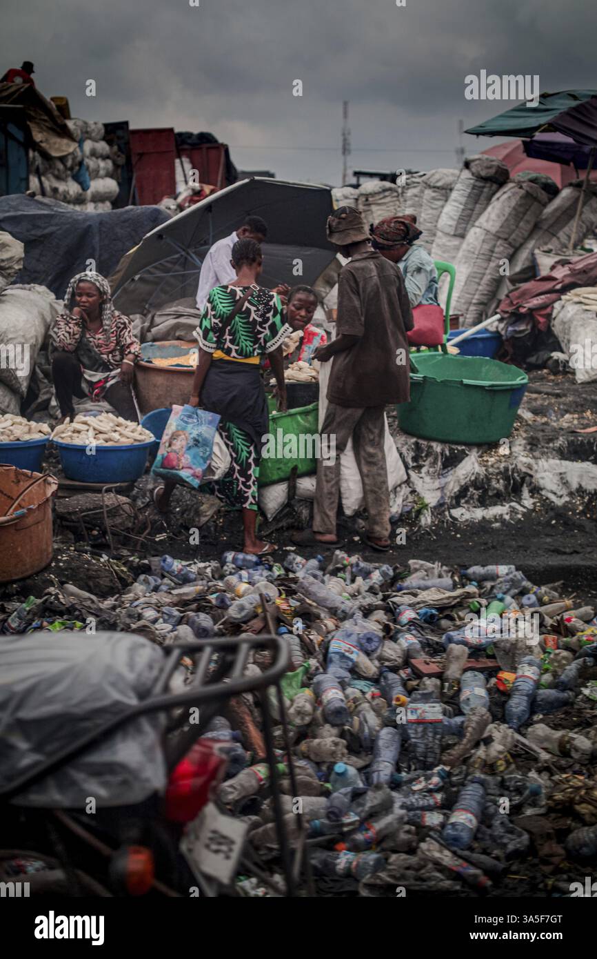Market in Kinshasa, stalls surrounded by plastic waste, environmental ...