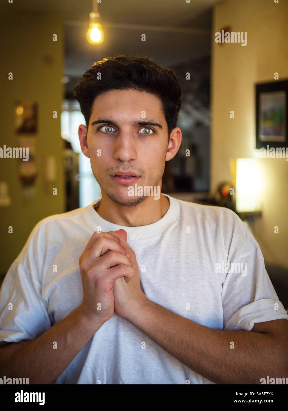 Surprised, scared, frightened, unsure handsome young man looking away ...