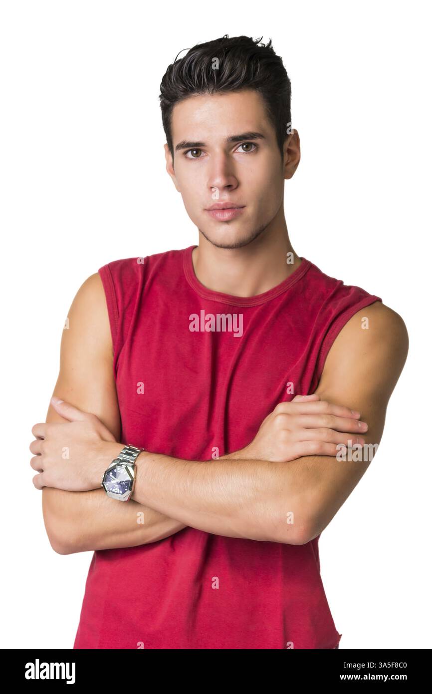 Serious looking young man wearing red t-shirt looking at camera ...