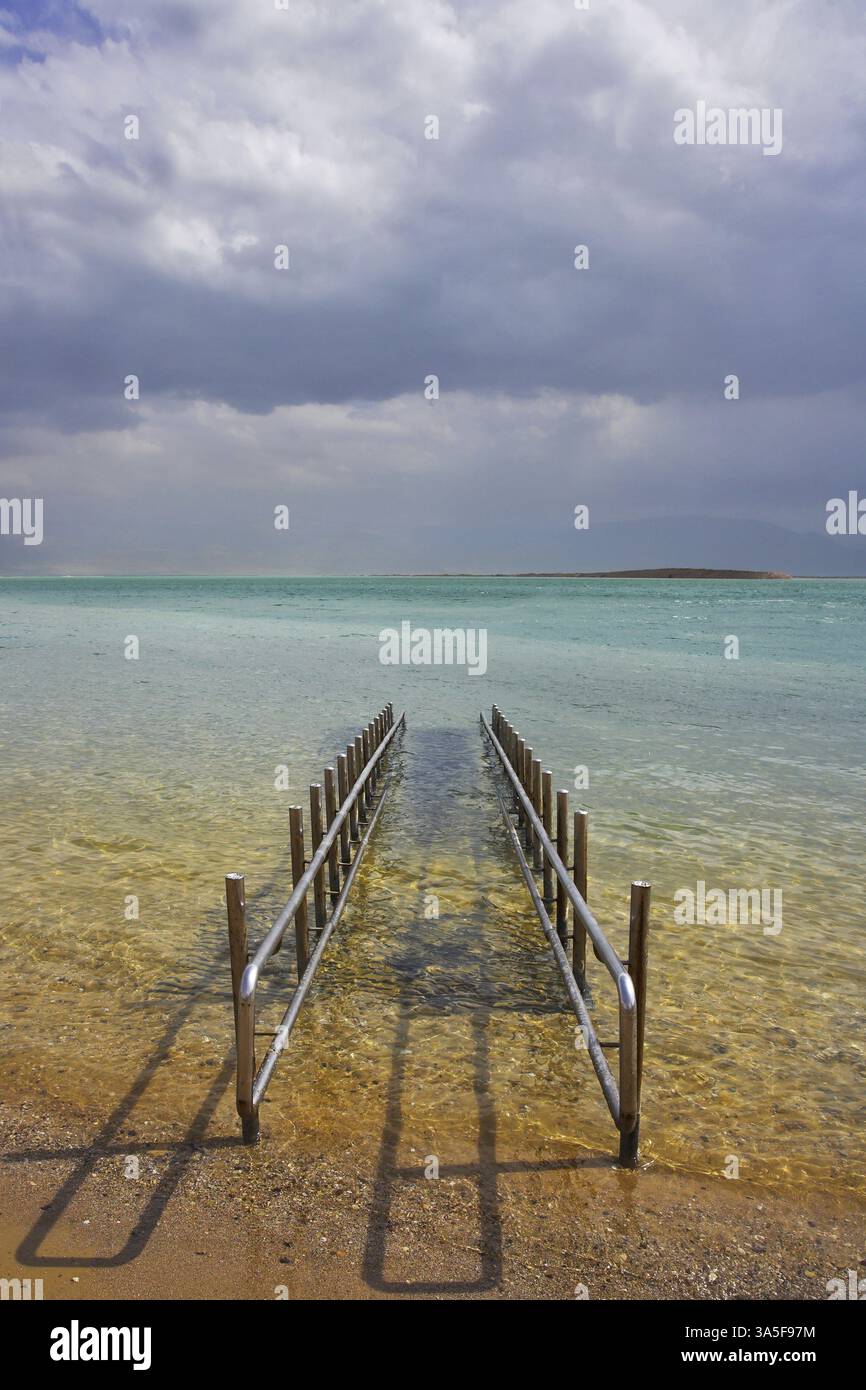 Descent in beach to the sea in spring thunder-storm Stock Photo - Alamy
