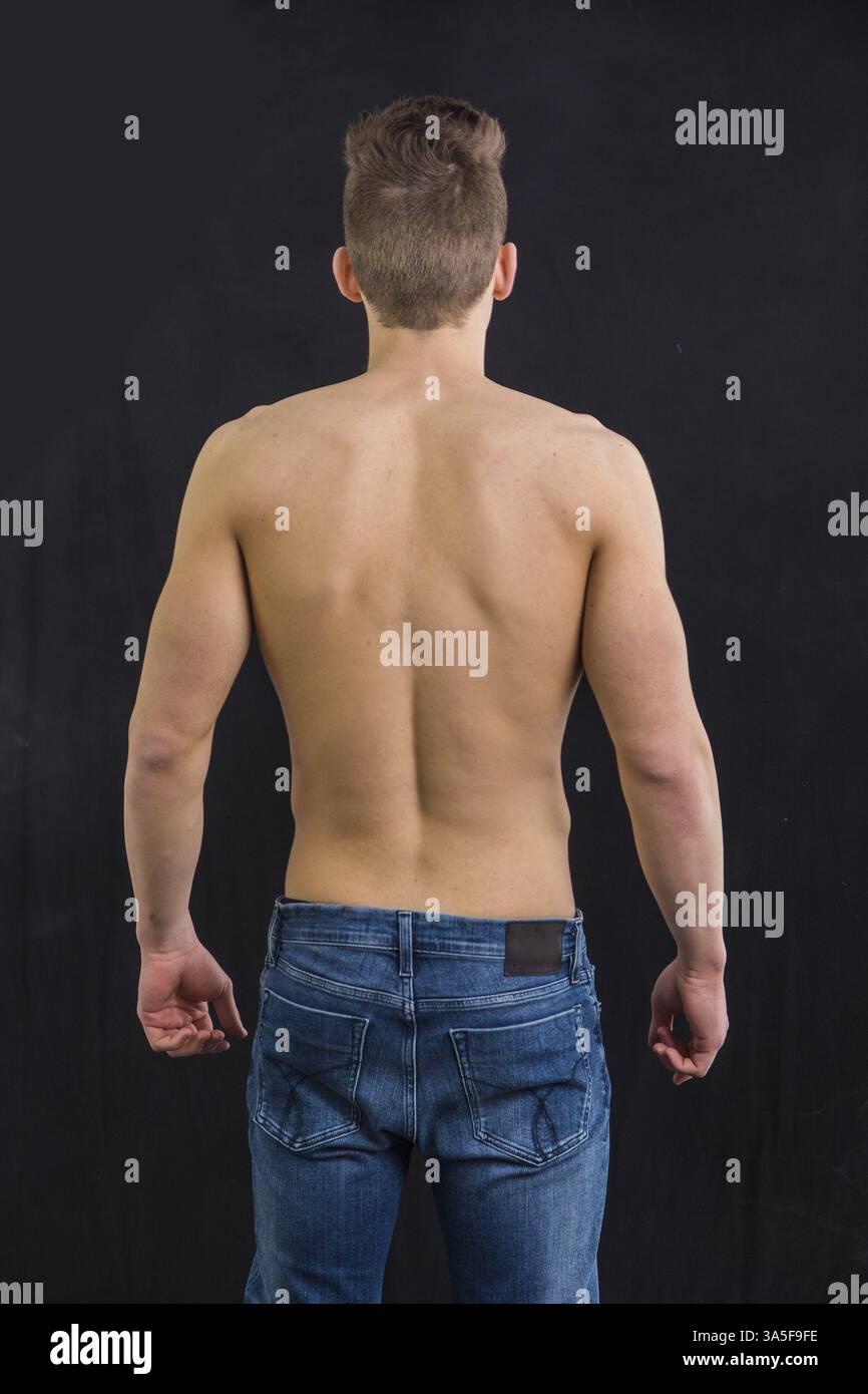 Muscular back of young man in relaxed pose. Isolated on black Stock ...