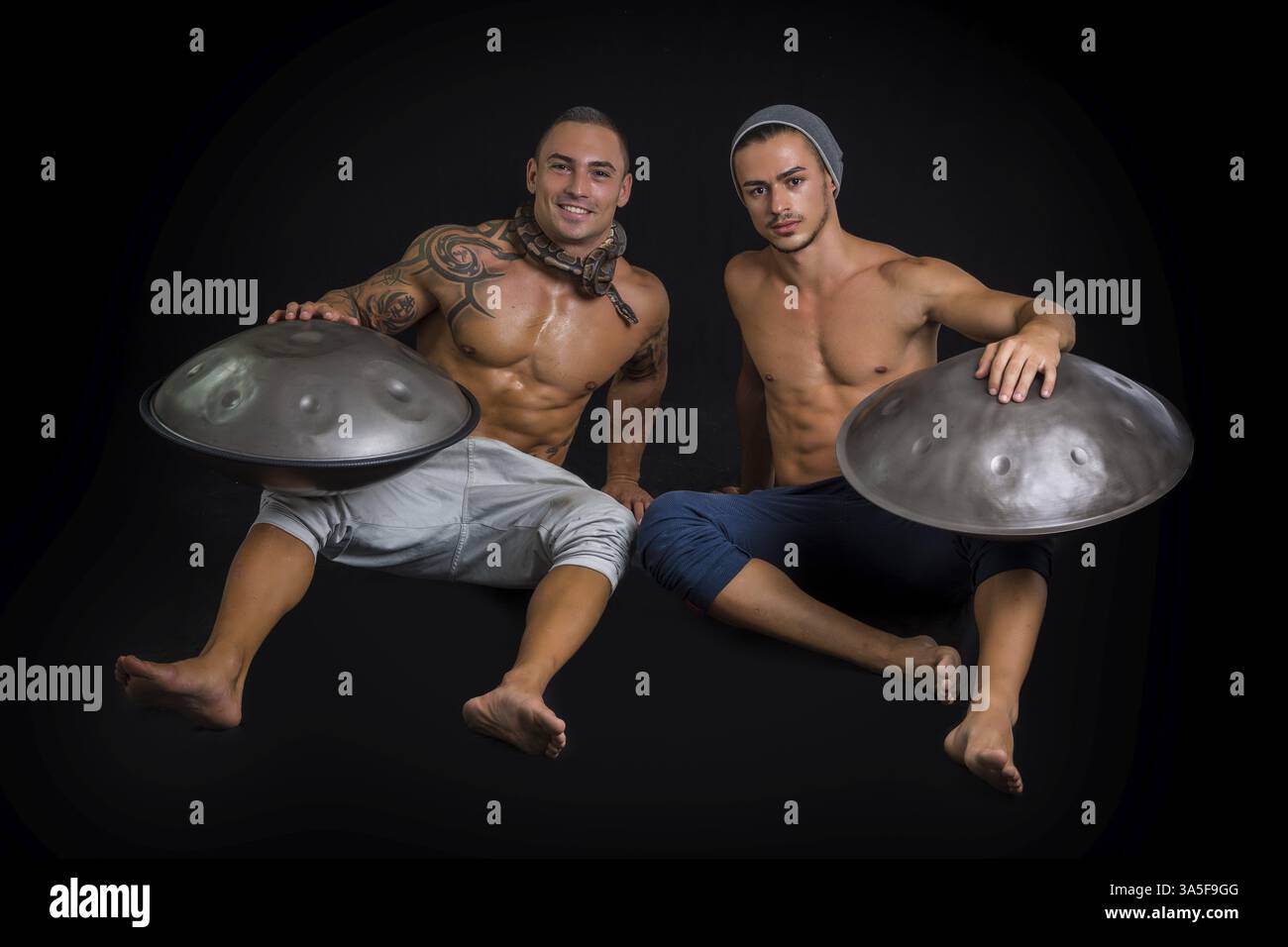 Two Exotic Male Drummers Drumming with Hands on Steel Pan Drums While ...