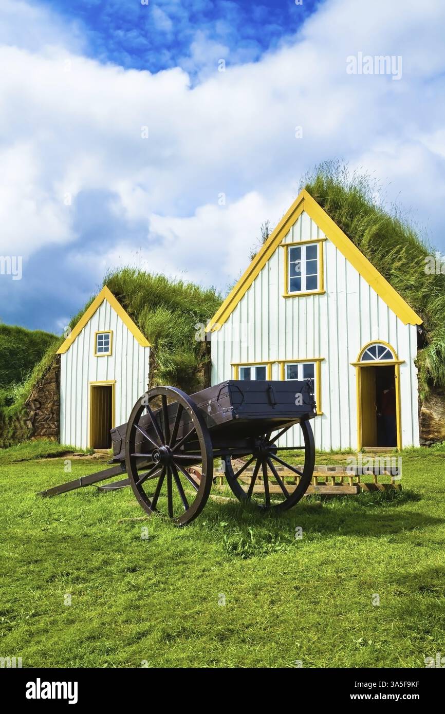 The ancient two-wheeled wooden cart on the front lawn. The village ...