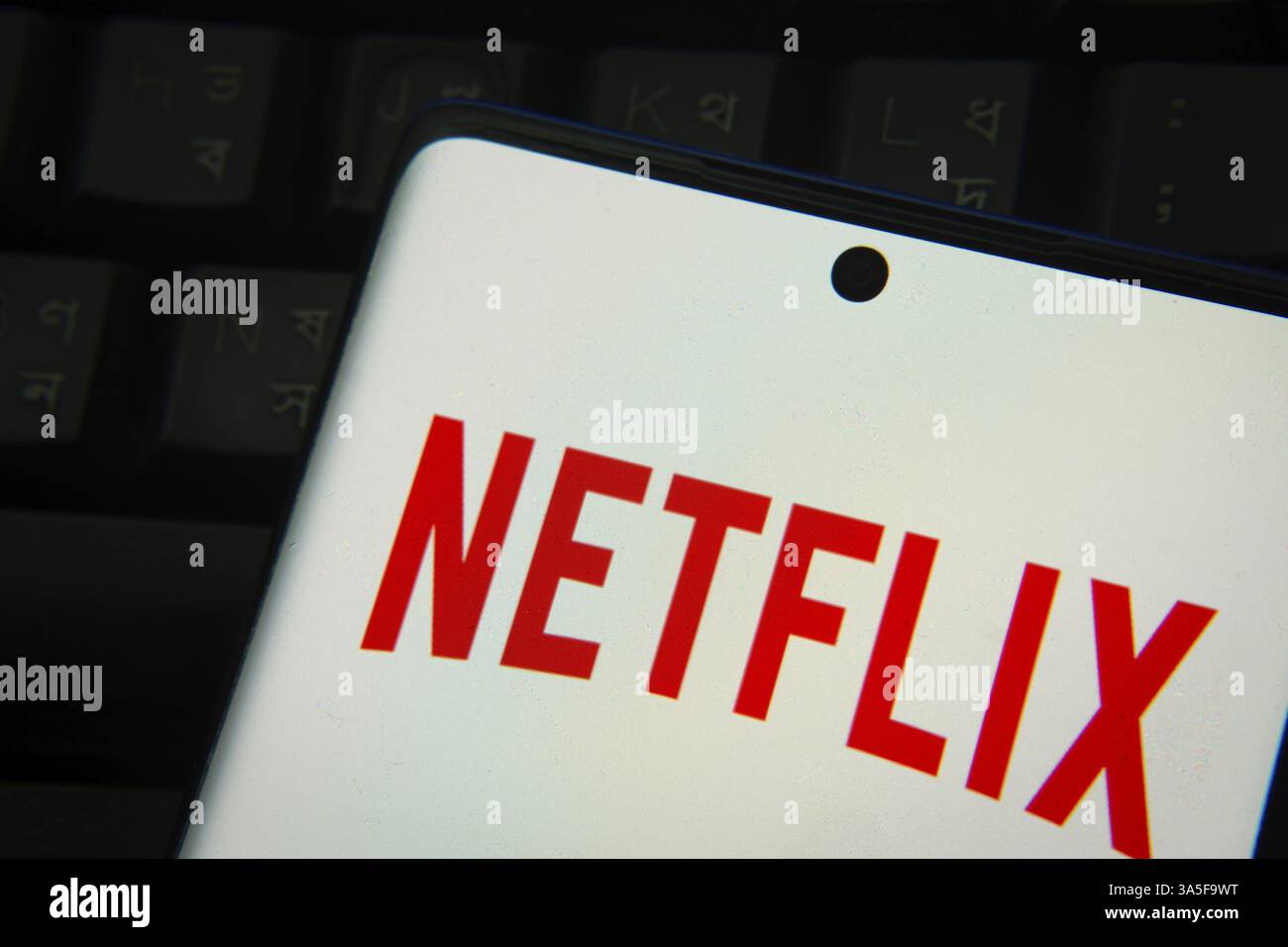 Smartphone on surface showing Netflix logo. Netflix is â€‹â€‹an ...