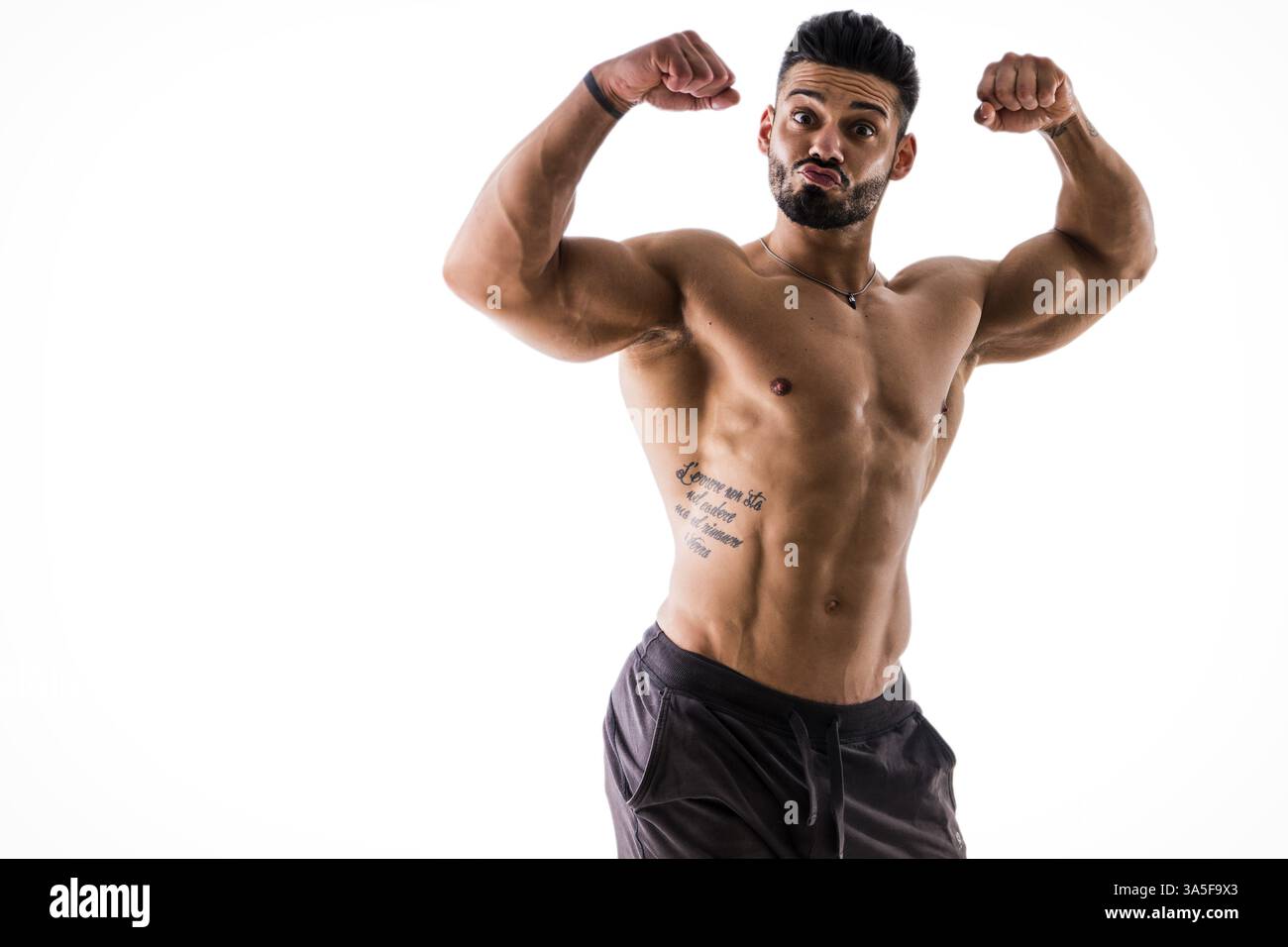 Handsome bodybuilder doing classic double biceps pose with funny, silly ...