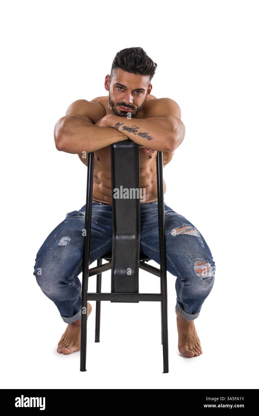 Muscular bodybuilder sitting on chair, looking at camera. Isolated on ...