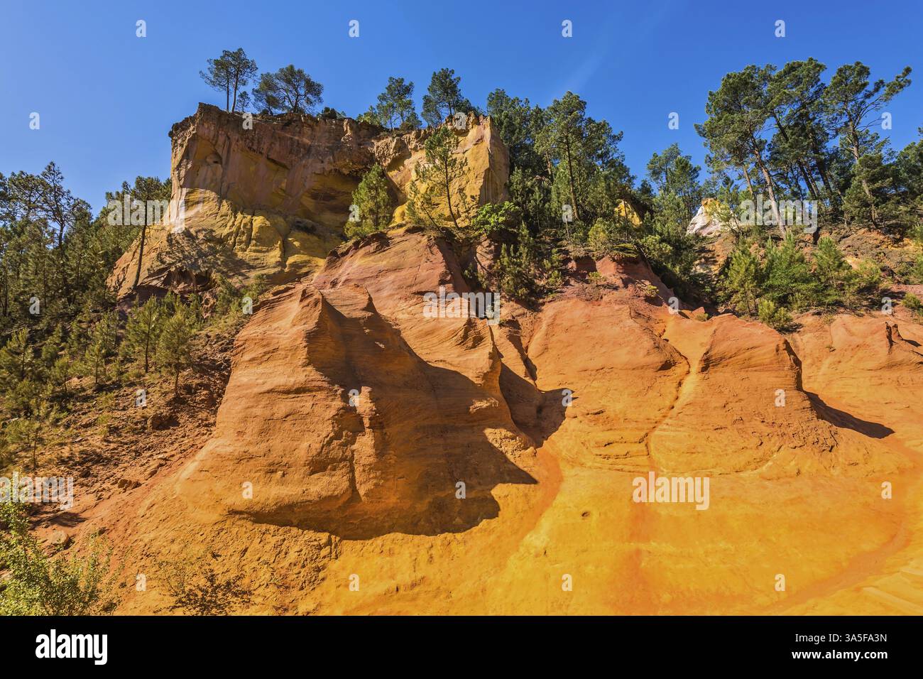 Steps for tourists on a steep slope. Unique red and orange hills in the ...
