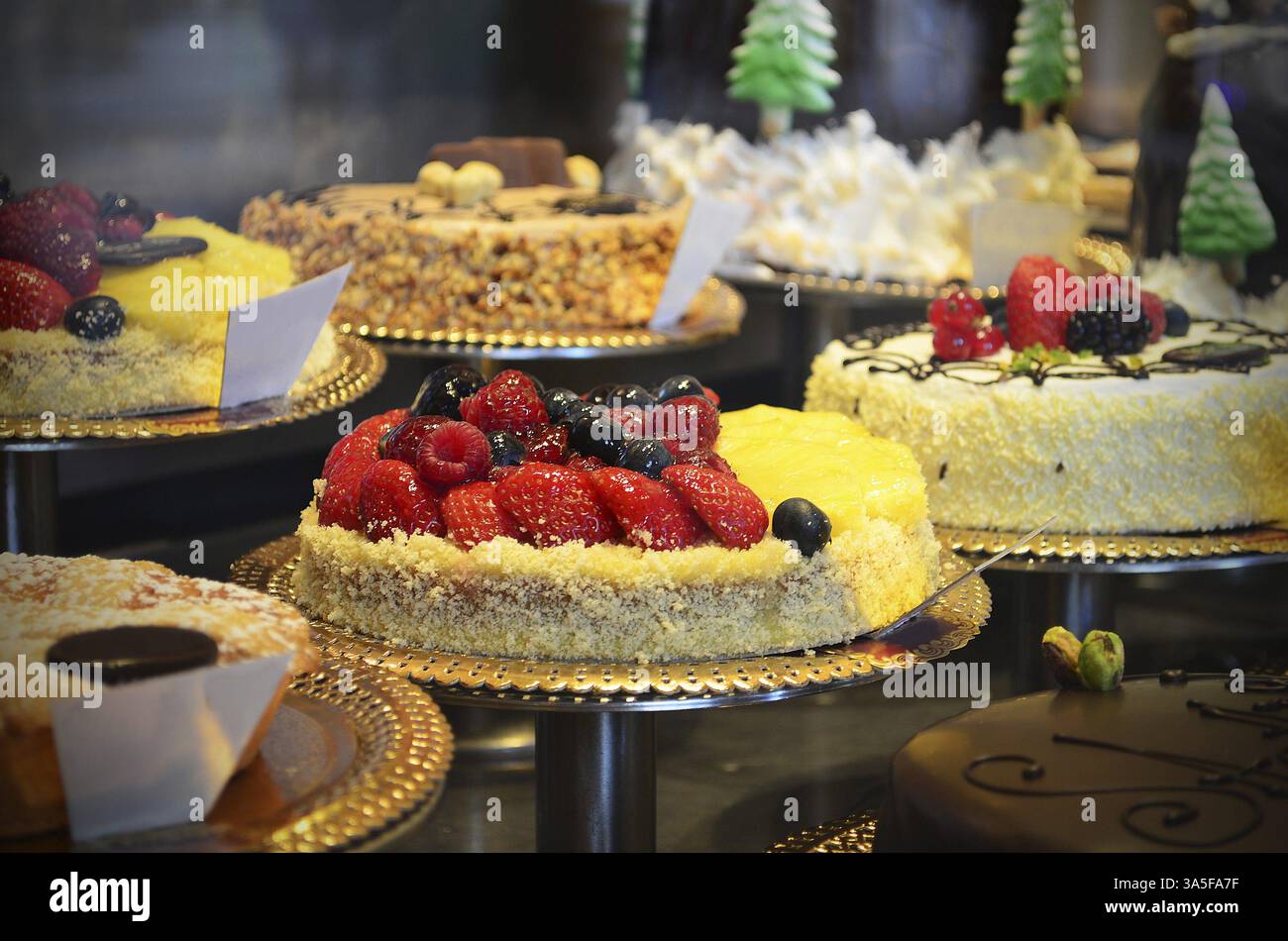 Delicious looking cakes in a shop window Stock Photo - Alamy