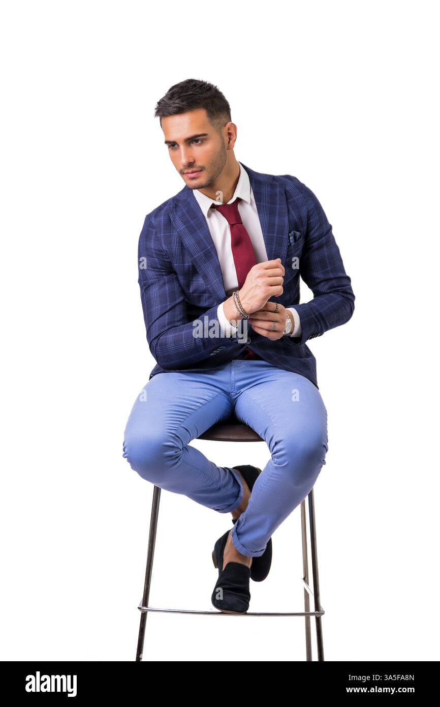 Handsome young man in blue business jacket and jeans posing isolated on ...