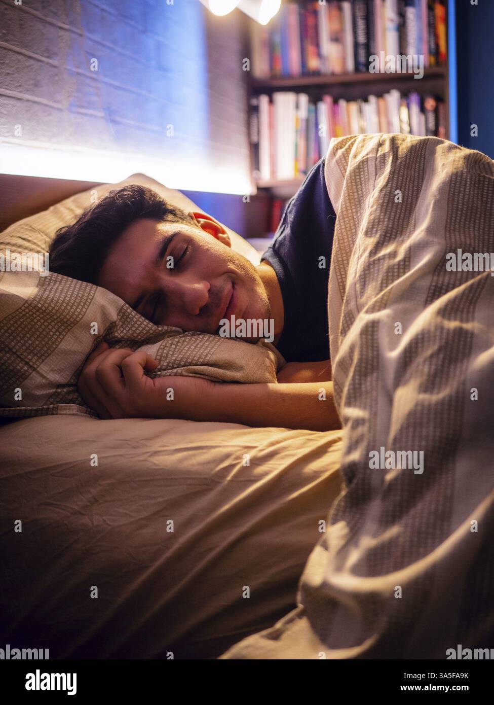 Handsome young man sleeping on white pillow, profile shot Stock Photo ...