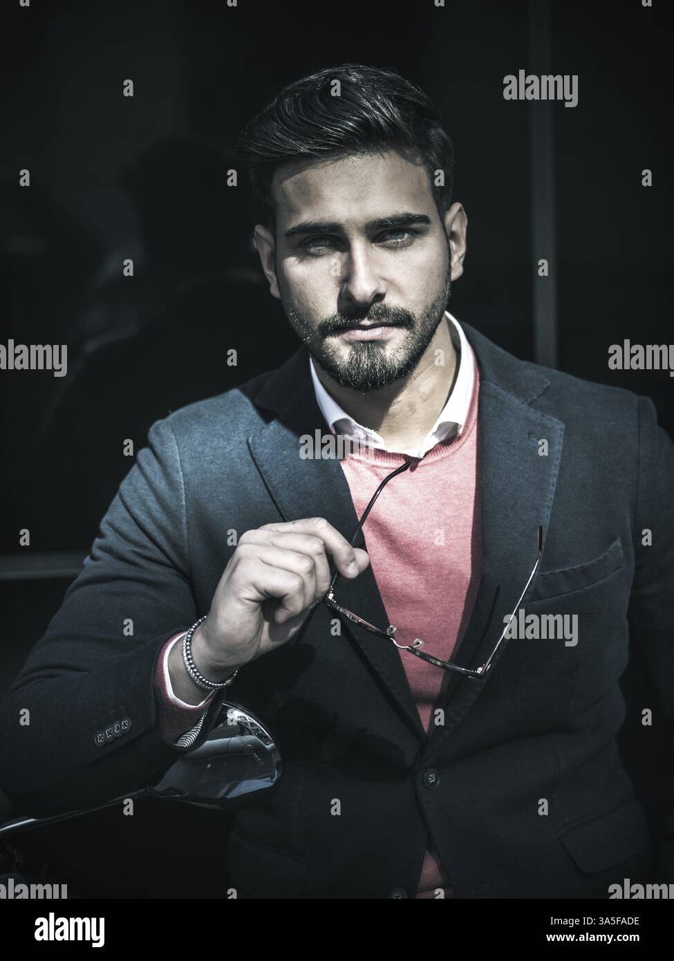 Young stylish man in suit and sunglasses standing by his classic ...