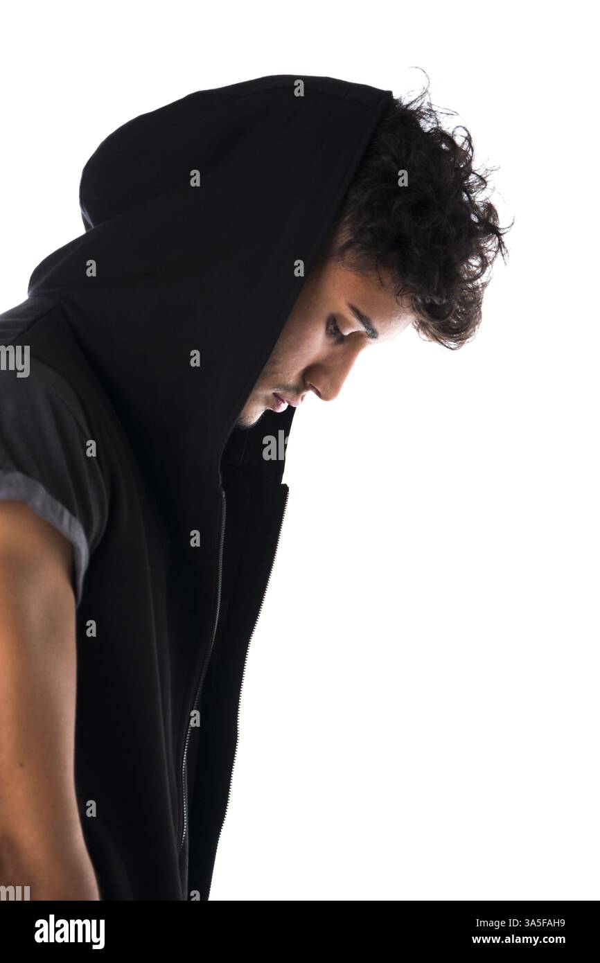 Profile of handsome tough young man in dark hoodie isolated on white ...