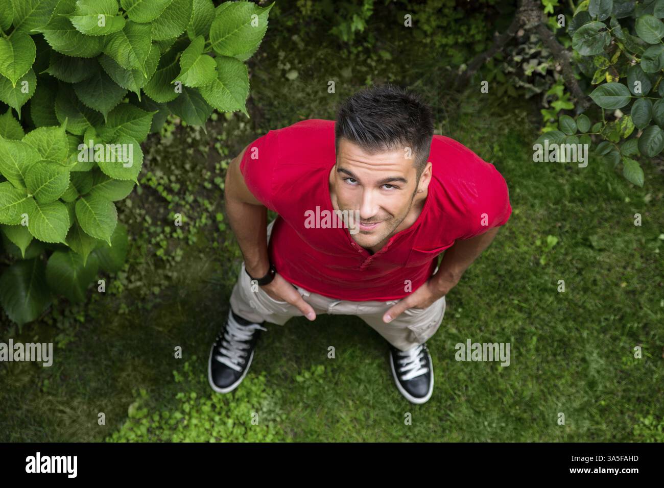Good looking, fit male model looking up with smile, outdoors on ...