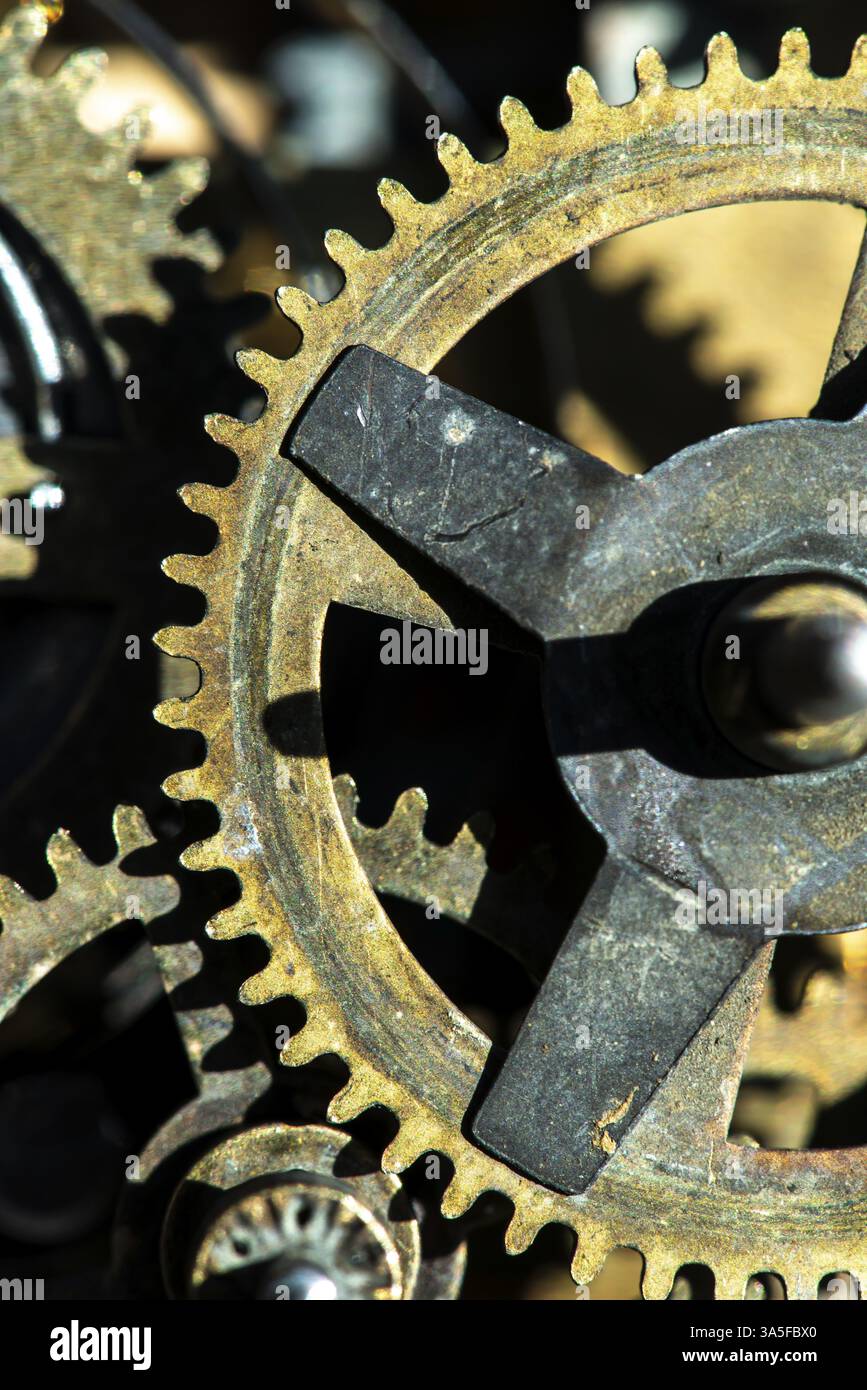 Close up metal gears mechanism. Golden colours. Hard light. Clock ...