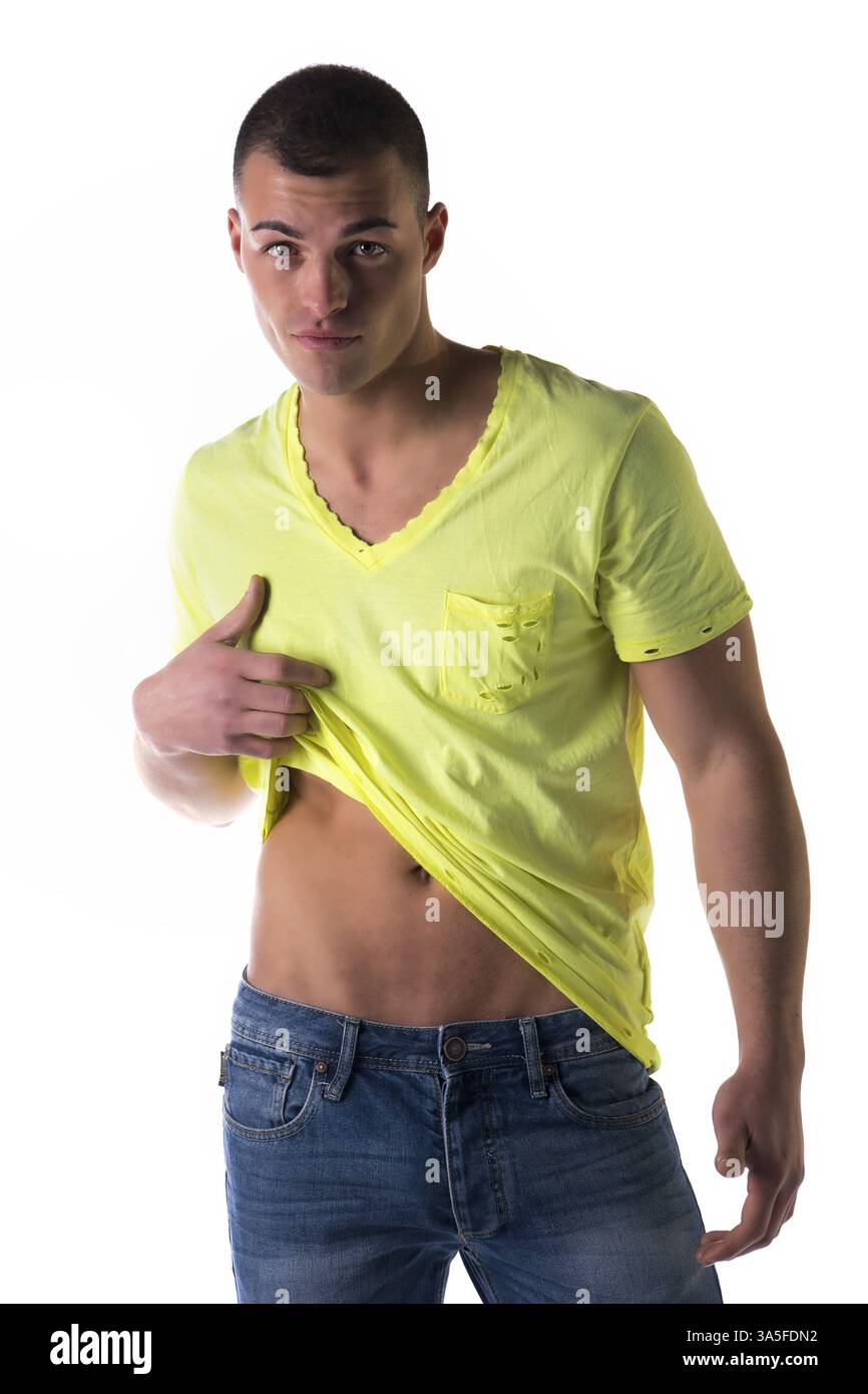 Handsome young man pulling up t-shirt to show lean stomach and abs ...