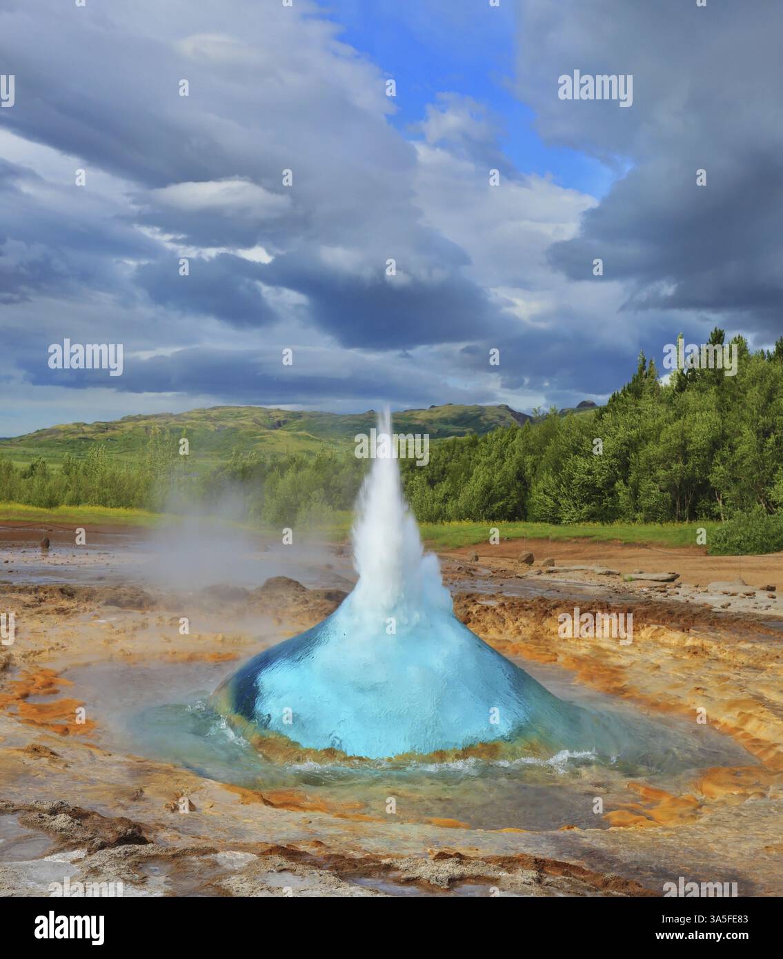 Summer in Iceland. Magnificent geyser Strokkur. The geyser throws out ...