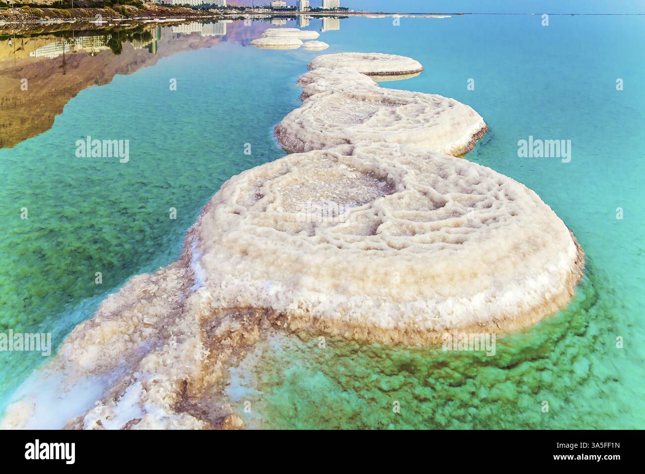 Early morning at the resorts of the Dead Sea. Picturesque white paths ...