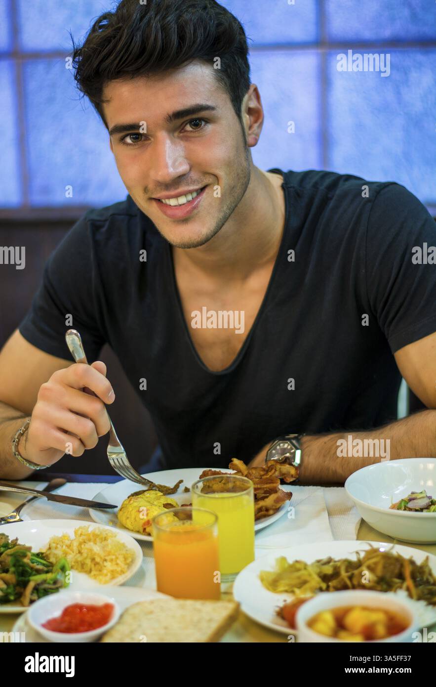 Attractive Young Man Eating Breakfast, Having a Slice of Bread with Jam ...