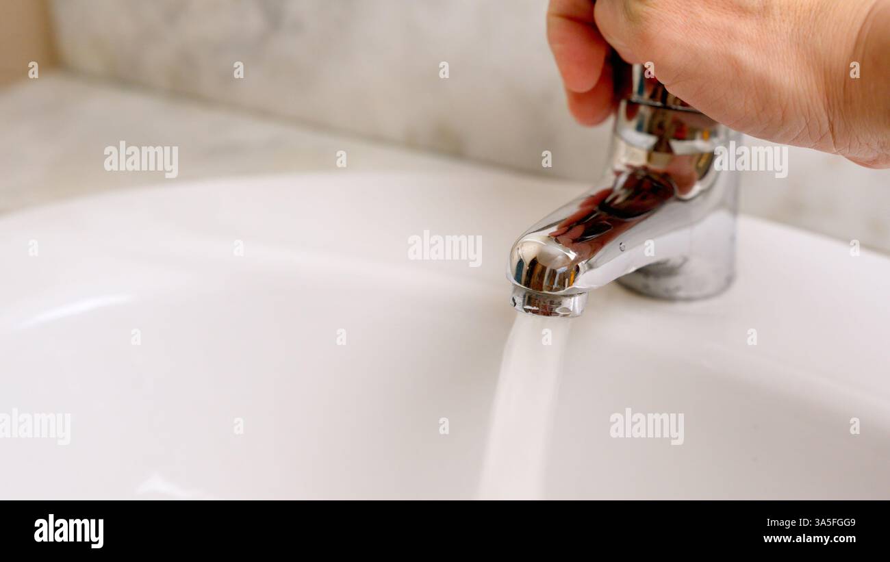 Hand opening bathroom utility hi-res stock photography and images - Alamy