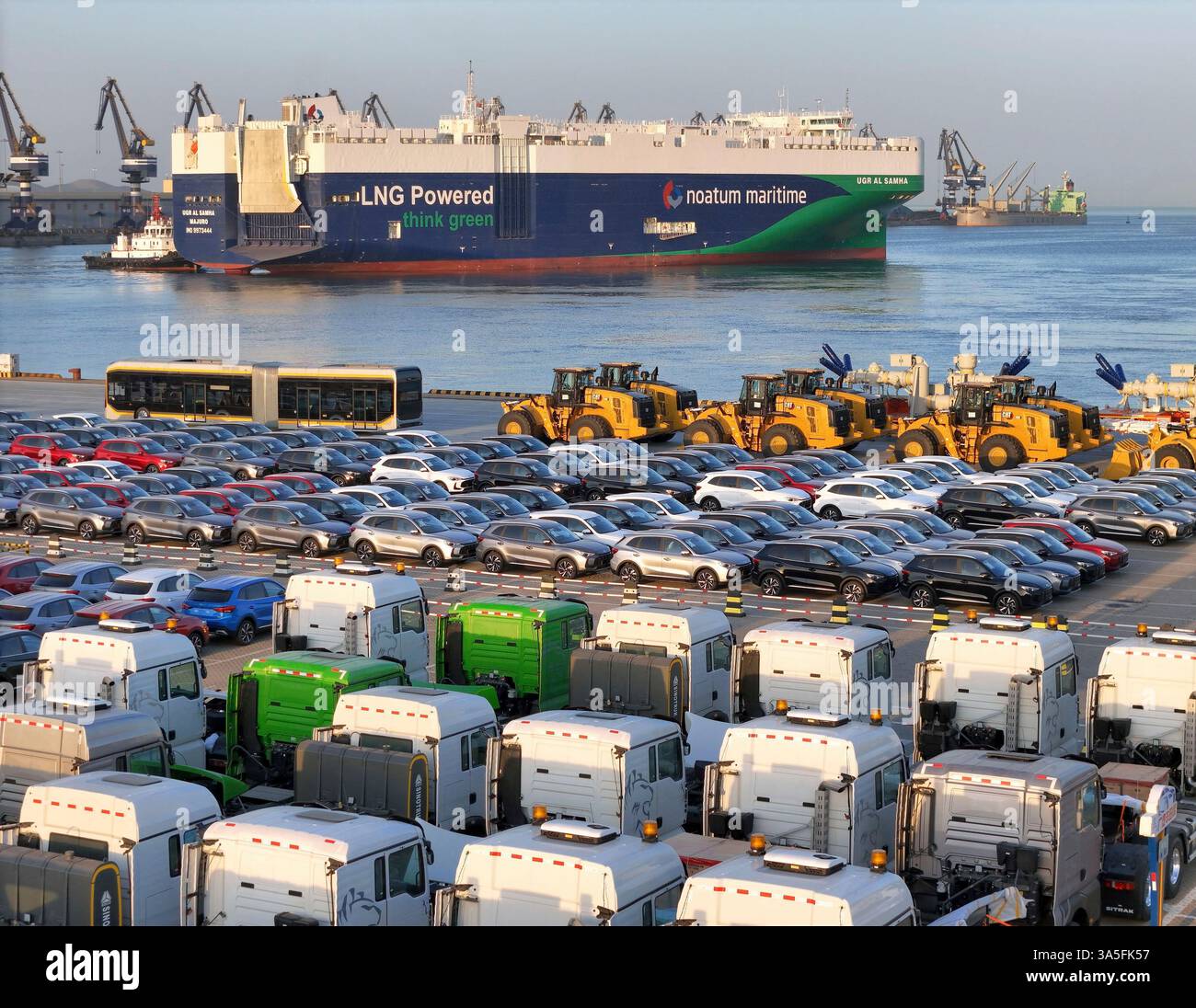 Vehicles wait for shipment on a ro-ro terminal at a sea port in Yantai ...