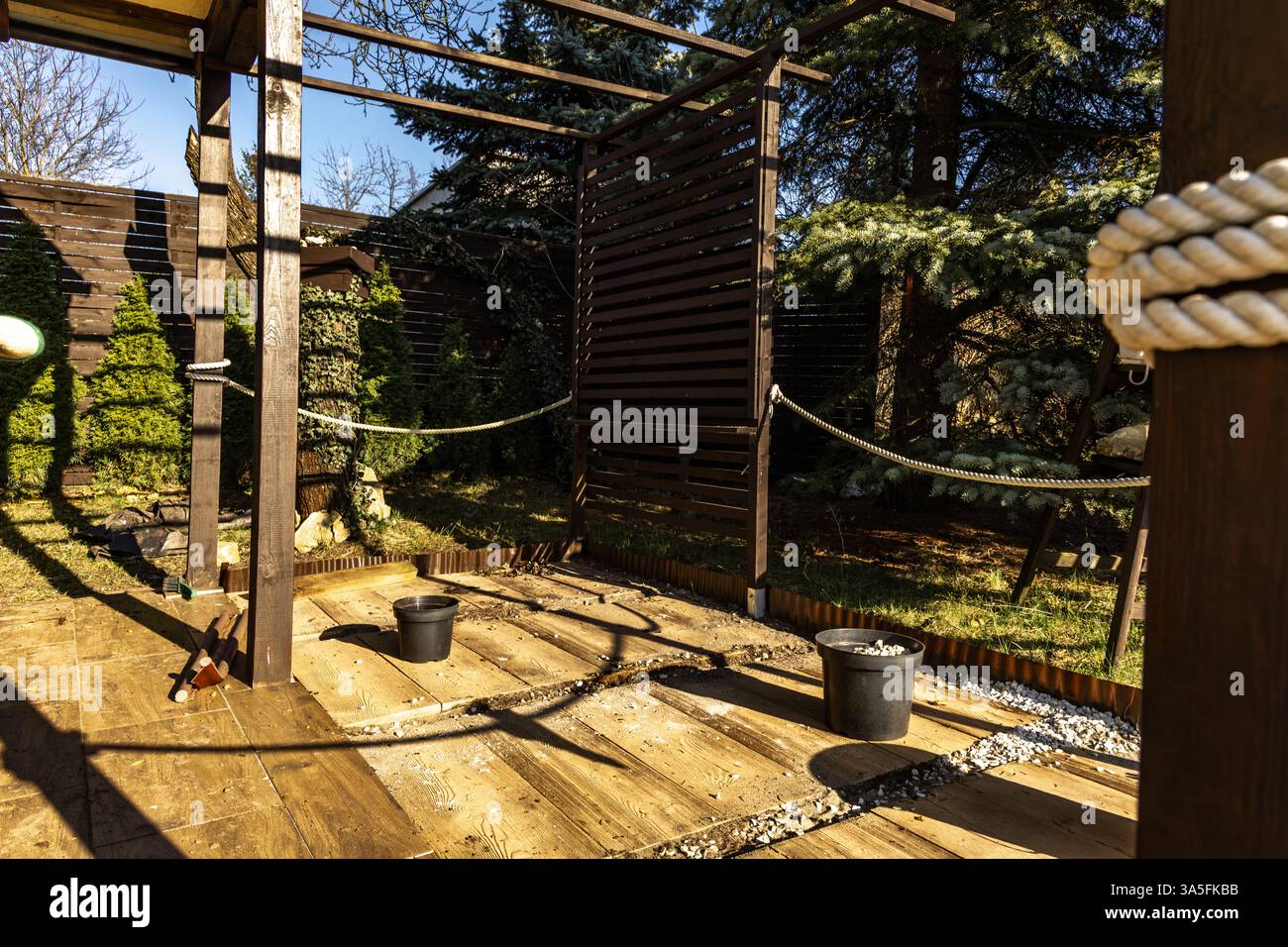 Laying slabs on a garden terrace, building a veranda, a floor made of ...