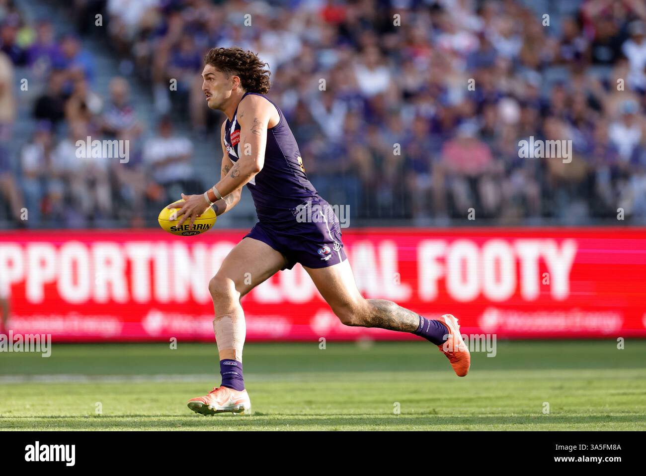 Perth, Australia. 23rd Mar, 2025. Luke Jackson of the Dockers runs the ...