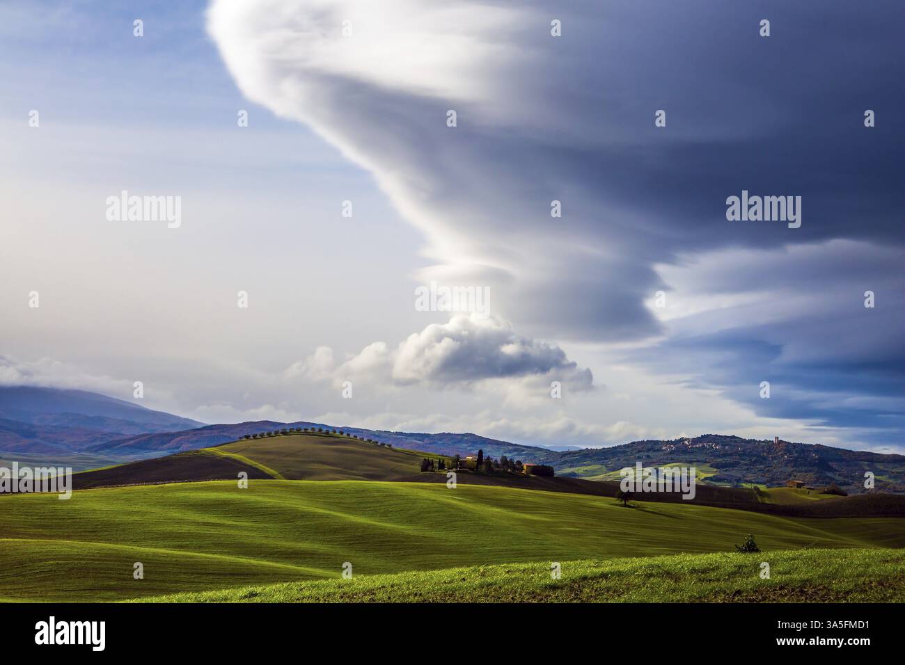 Gorgeous powerful clouds over Tuscany hills. Agritourism. Rural farms ...