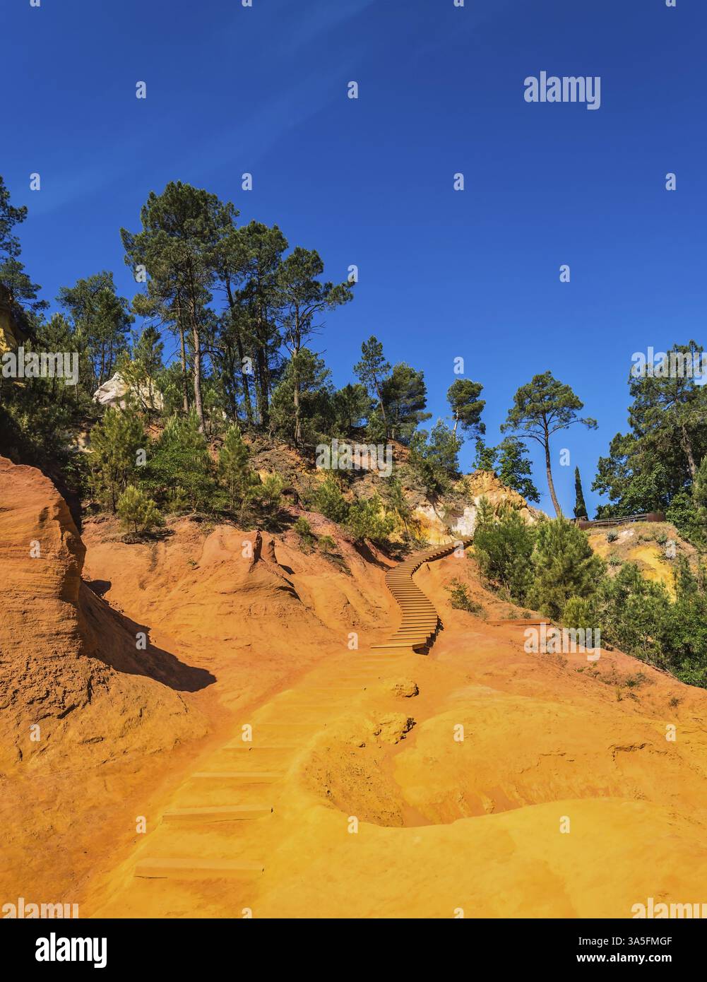 Steps for tourists on a steep slope. Unique red and orange hills in the ...