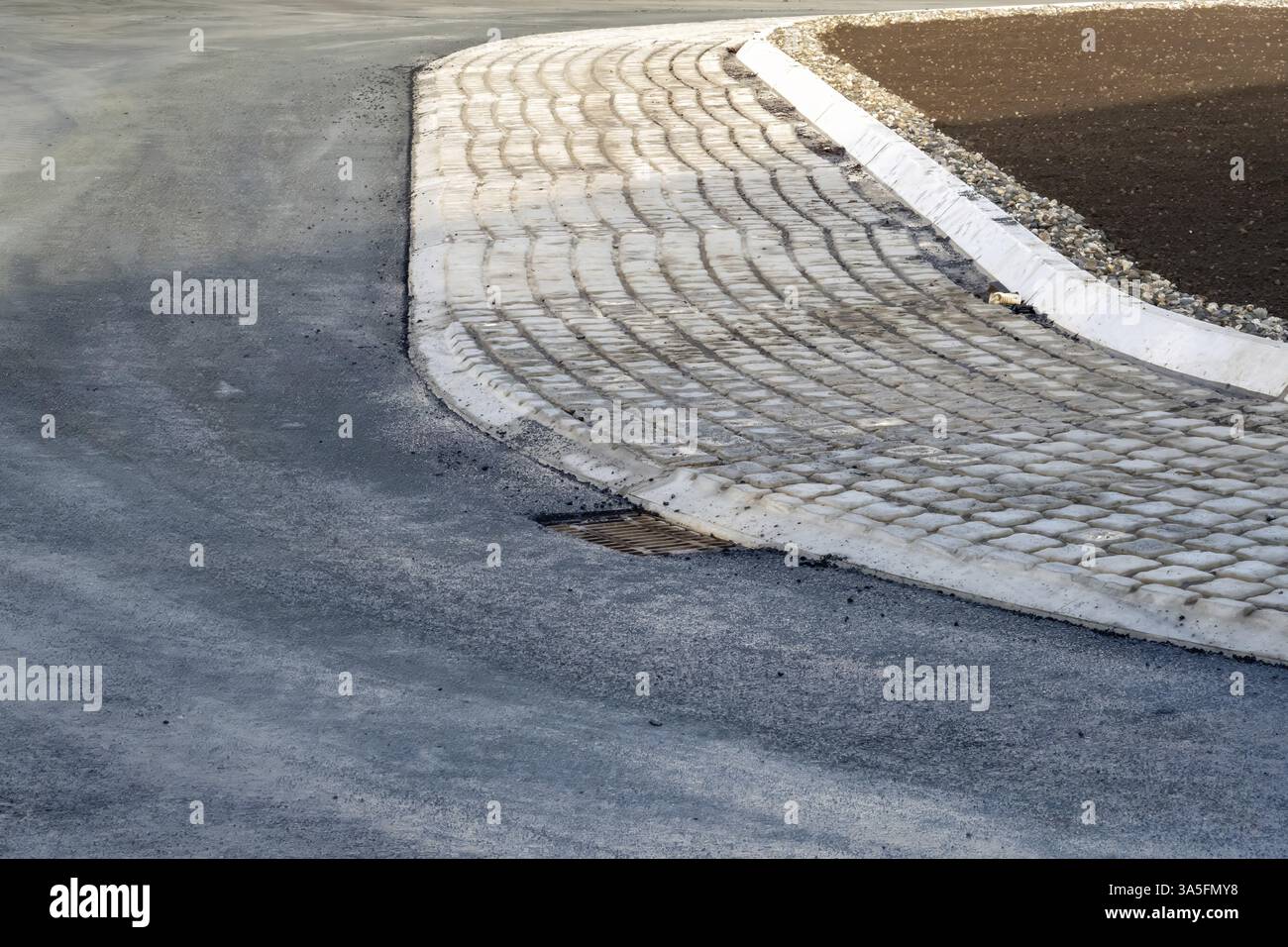 Newly built cobblestone driveway merging into an asphalt road ...