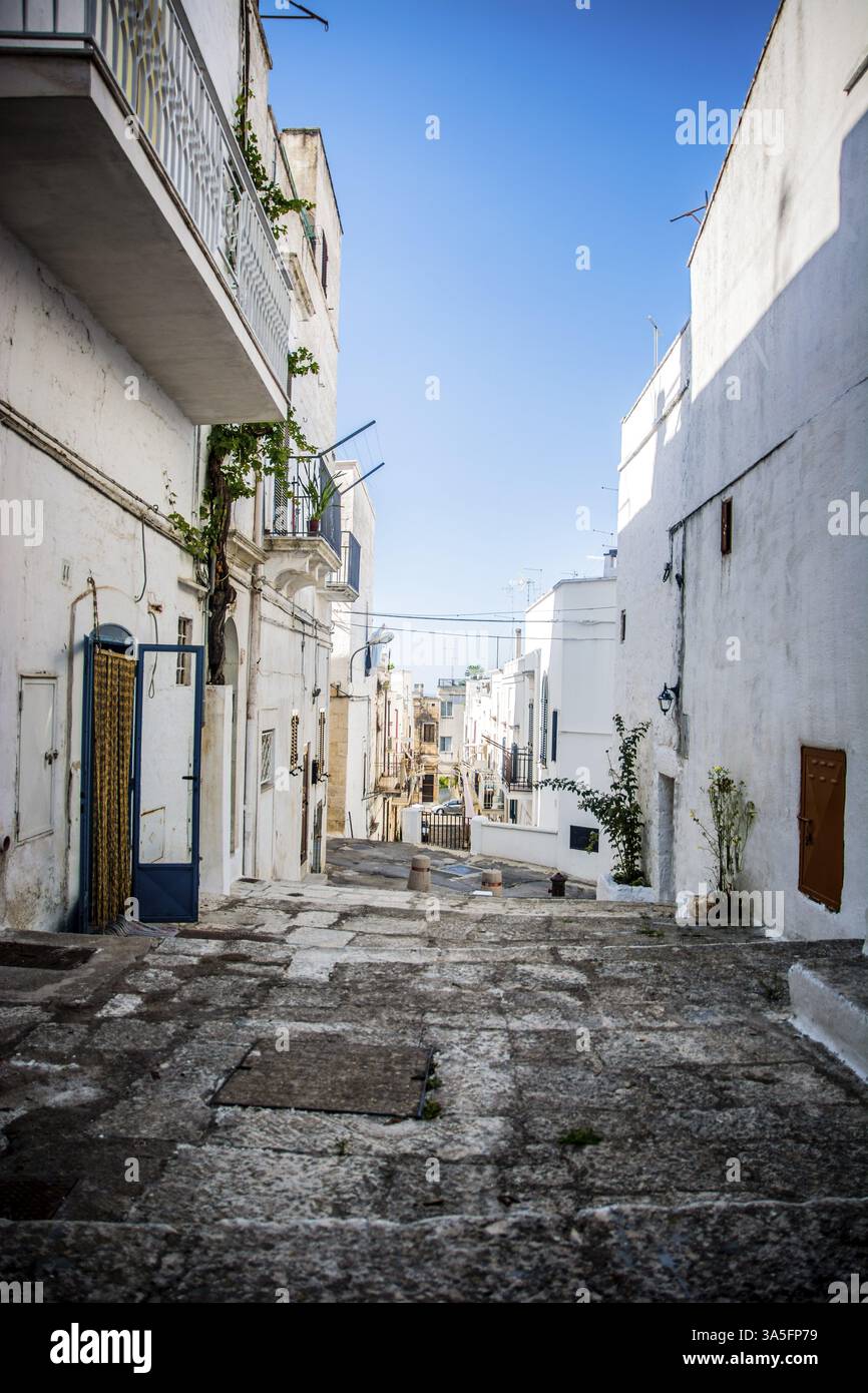 Narrow and old street or alley in italian town of Ostuni in Puglia ...