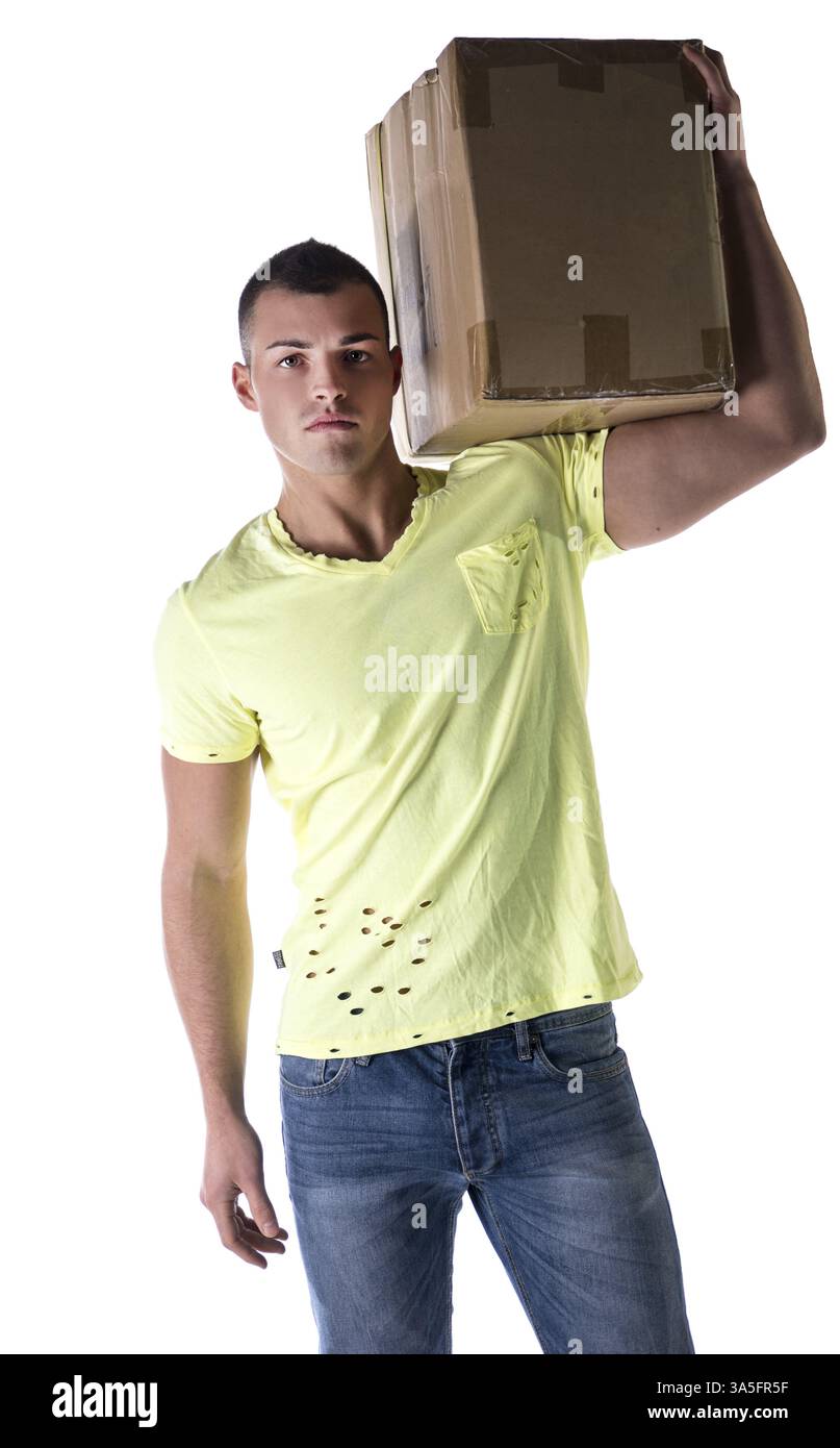 Handsome young man carrying cardboard box on shoulder, isolated on ...
