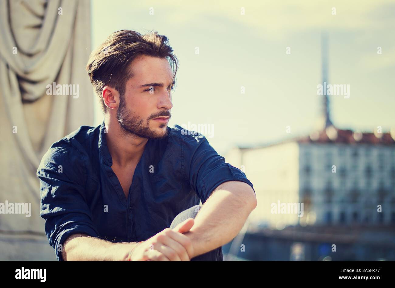 One handsome young man in urban setting in European city, Turin in ...