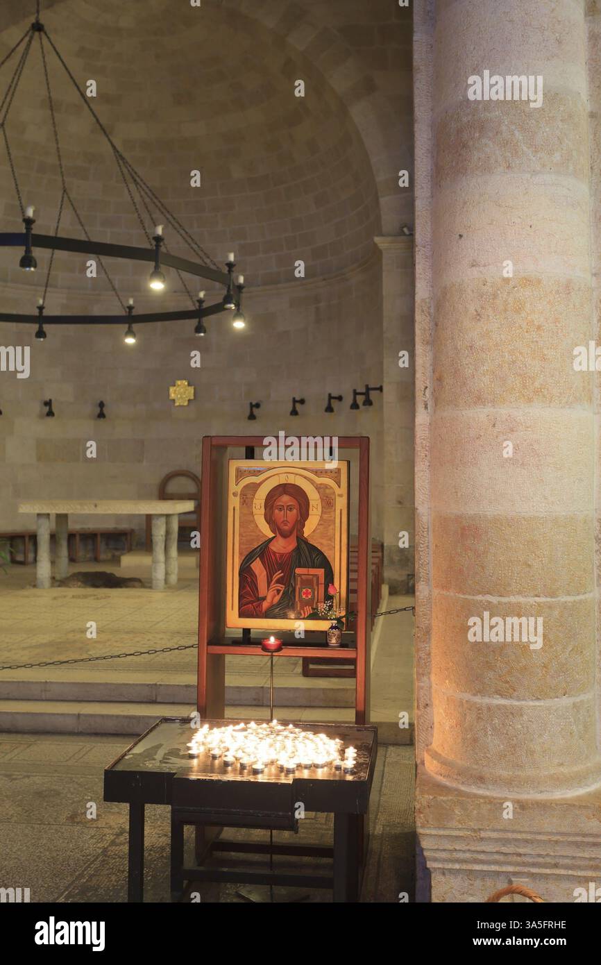 Magnificent old icon of Jesus Christ, and a table with burning candles ...
