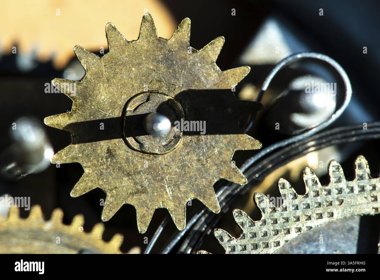 Close up metal gears mechanism. Golden colours. Hard light. Clock ...