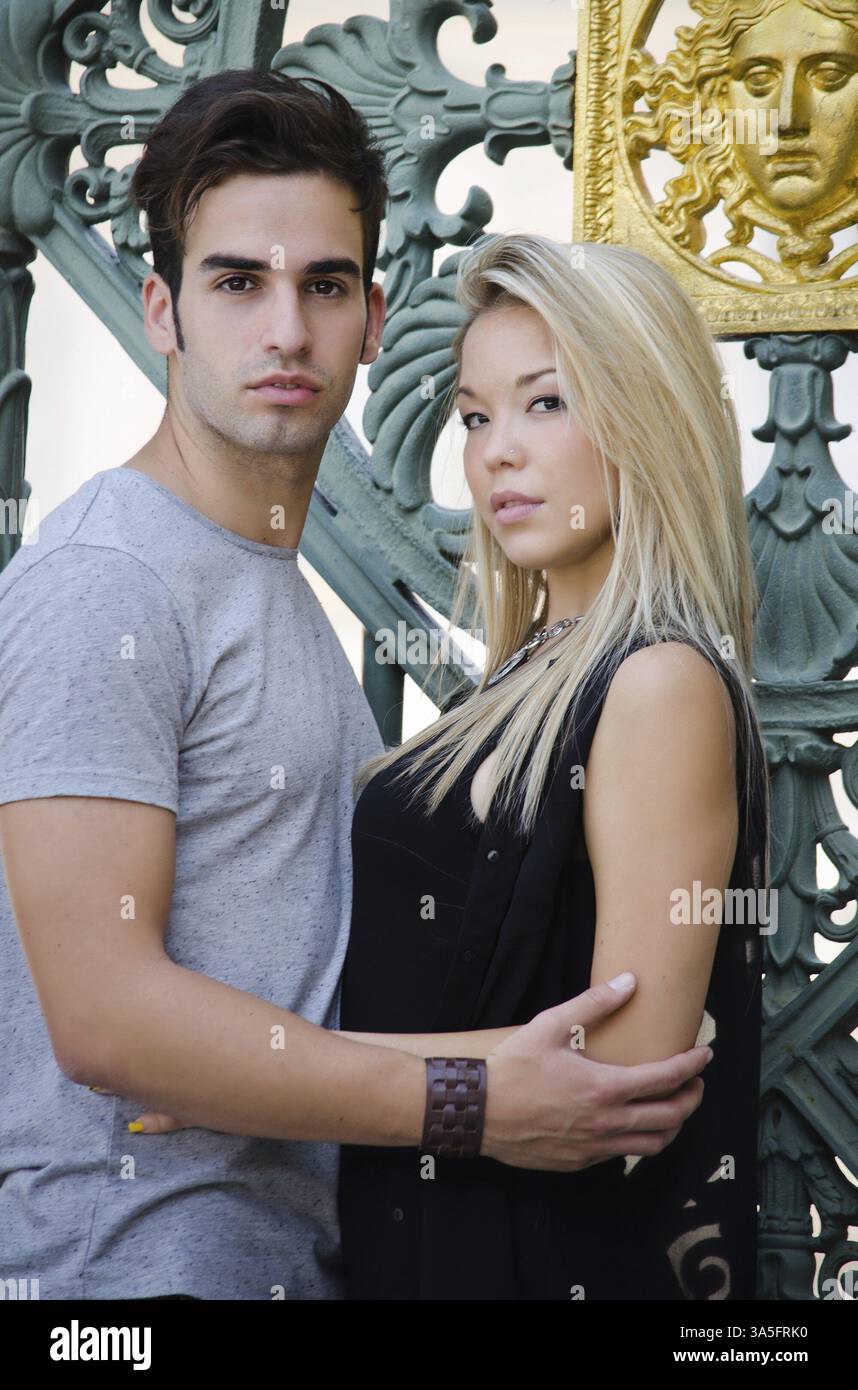 Attractive couple holding each other looking in camera, standing Stock ...